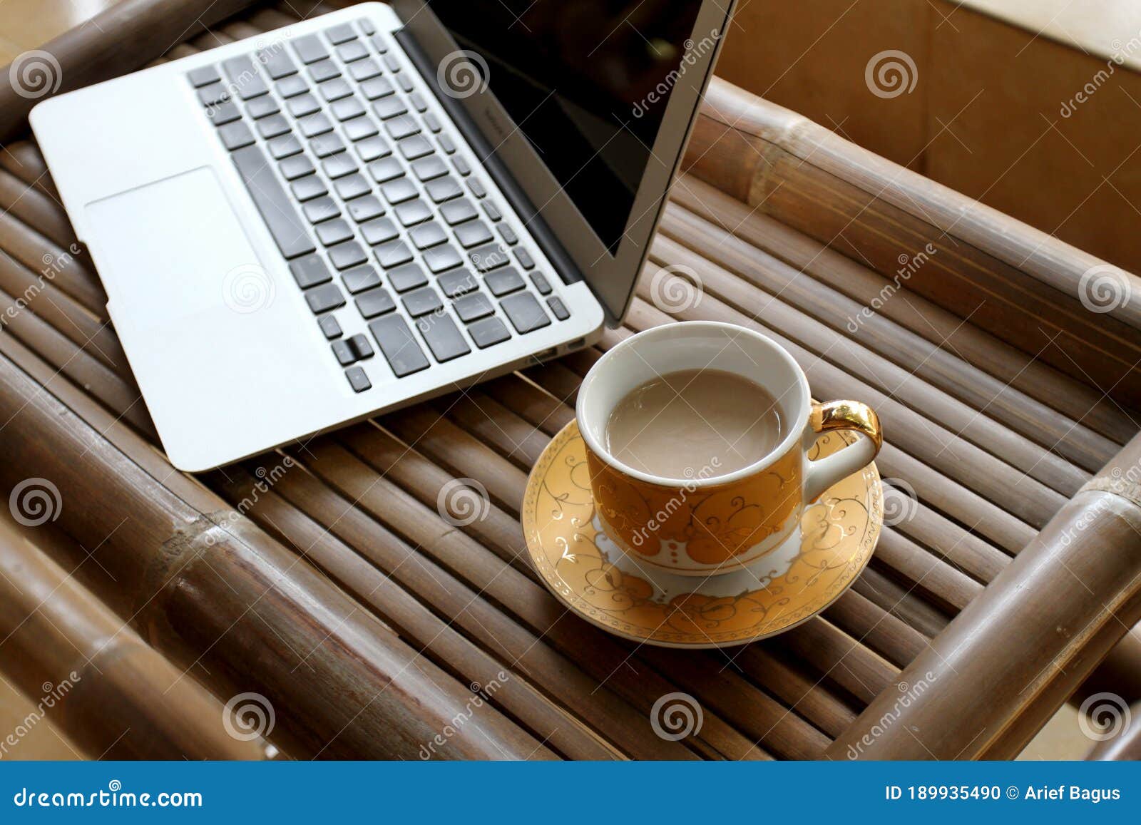 A Cup of Chocolate Milk and a Laptop Computer on a Bamboo Table Stock ...