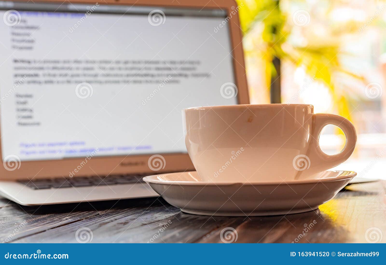 A Cup of Coffee Against a Laptop Screen. Writing a Journal Concept ...