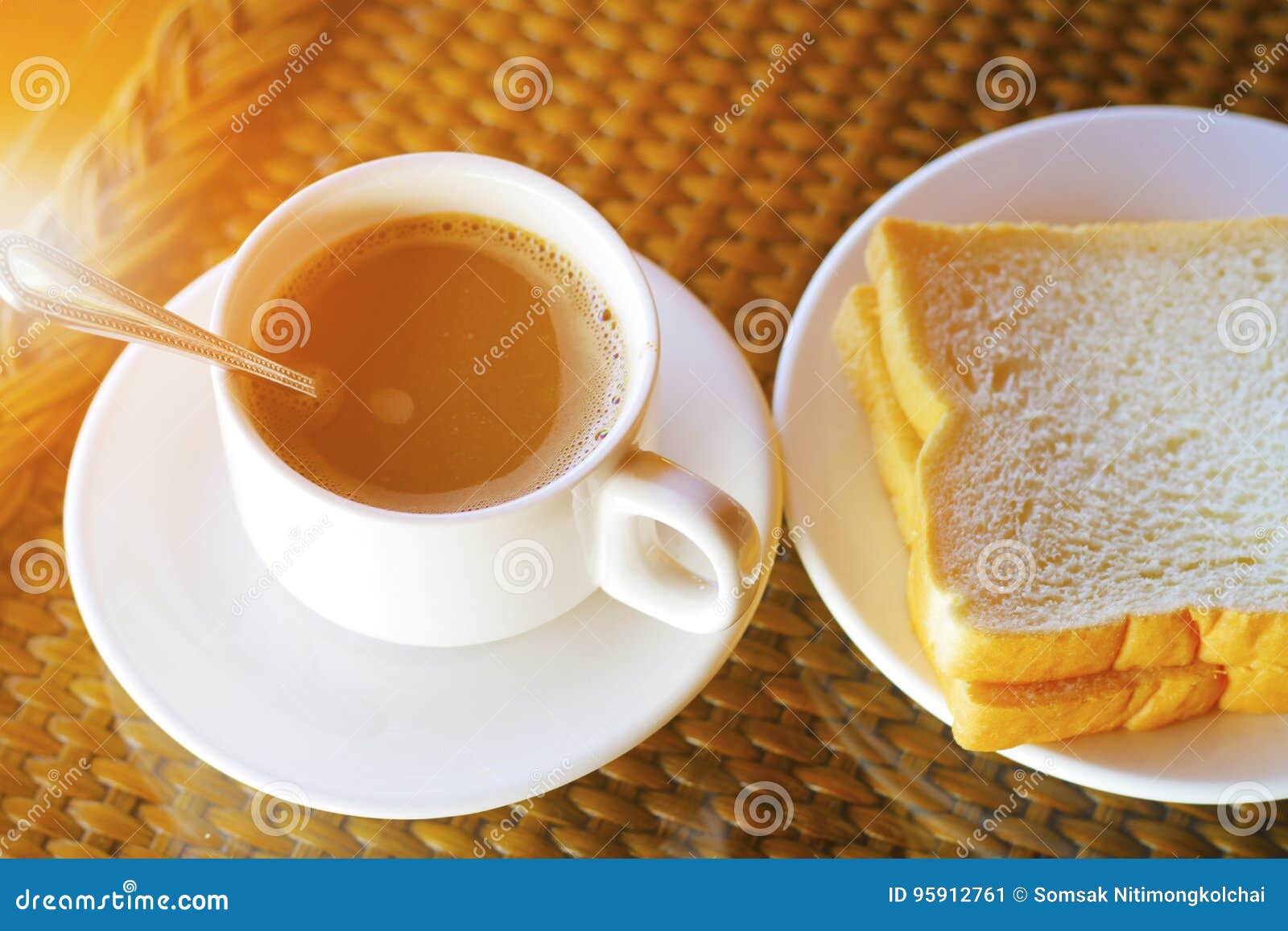 Cup of Coffee and Dish of Bread on the Breakfast Table in the Morning ...
