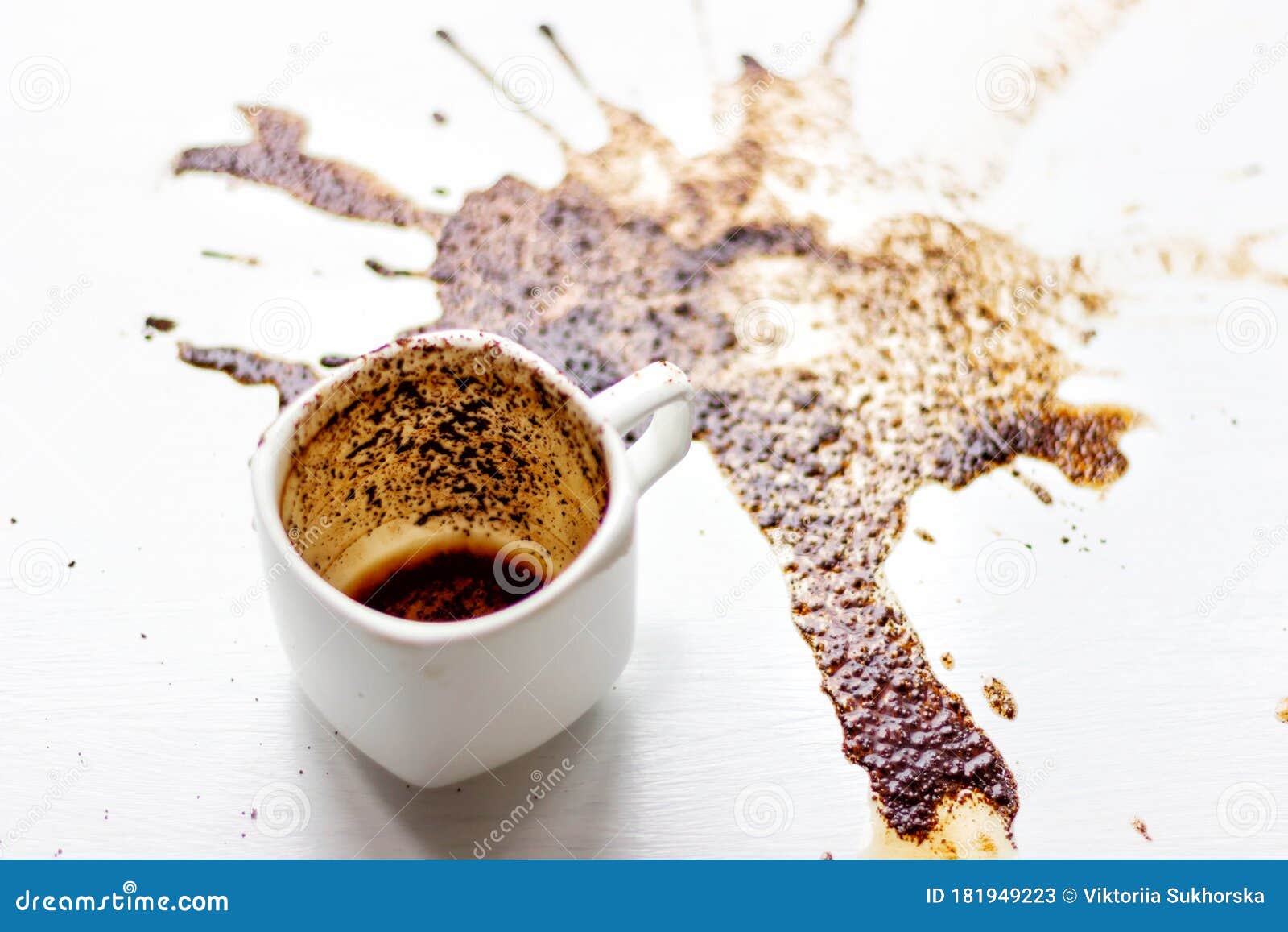 A Cup of Custard Coffee Spilled on a White Table Background, Side View ...