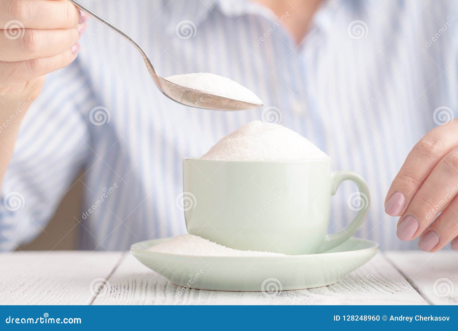 Cup Filled with Sugar To the Top. Hand Putting a Much More Sugar Stock ...