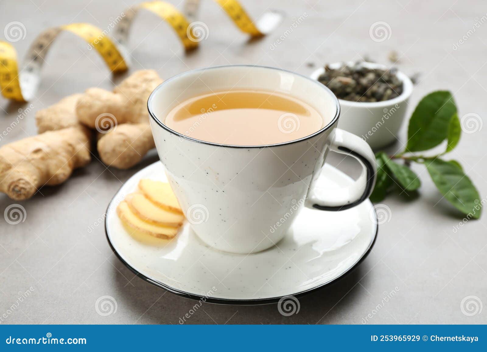 Cup of Herbal Diet Tea, Ginger and Measuring Tape on Light Table Stock ...