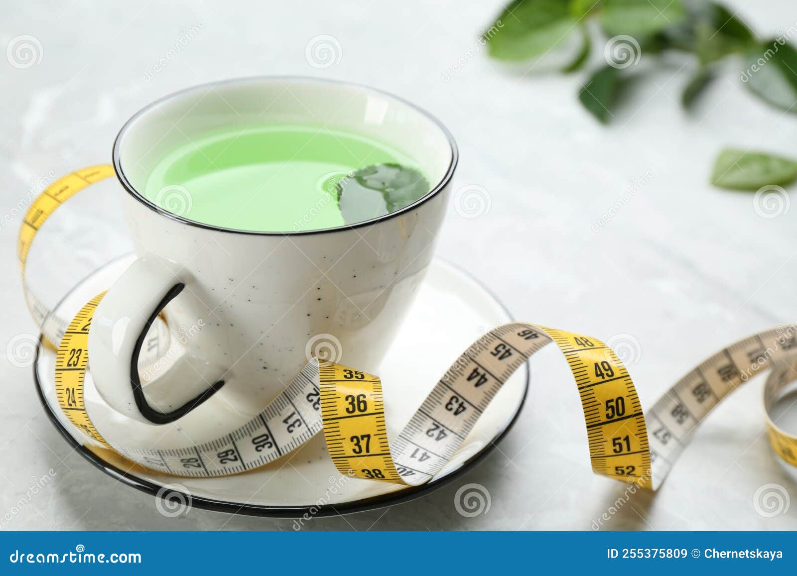 Cup of Herbal Diet Tea and Measuring Tape on Light Table Stock Image ...