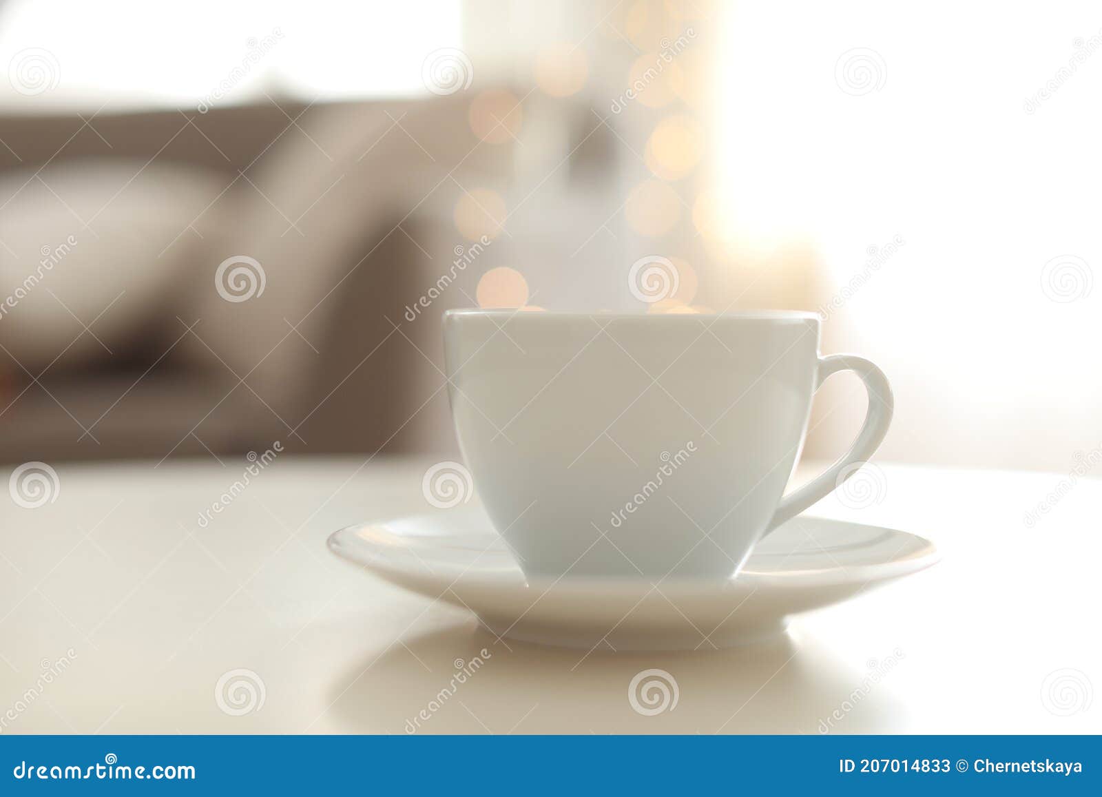 Cup of Hot Drink on Table Against Blurred Lights. Bokeh Effect Stock ...