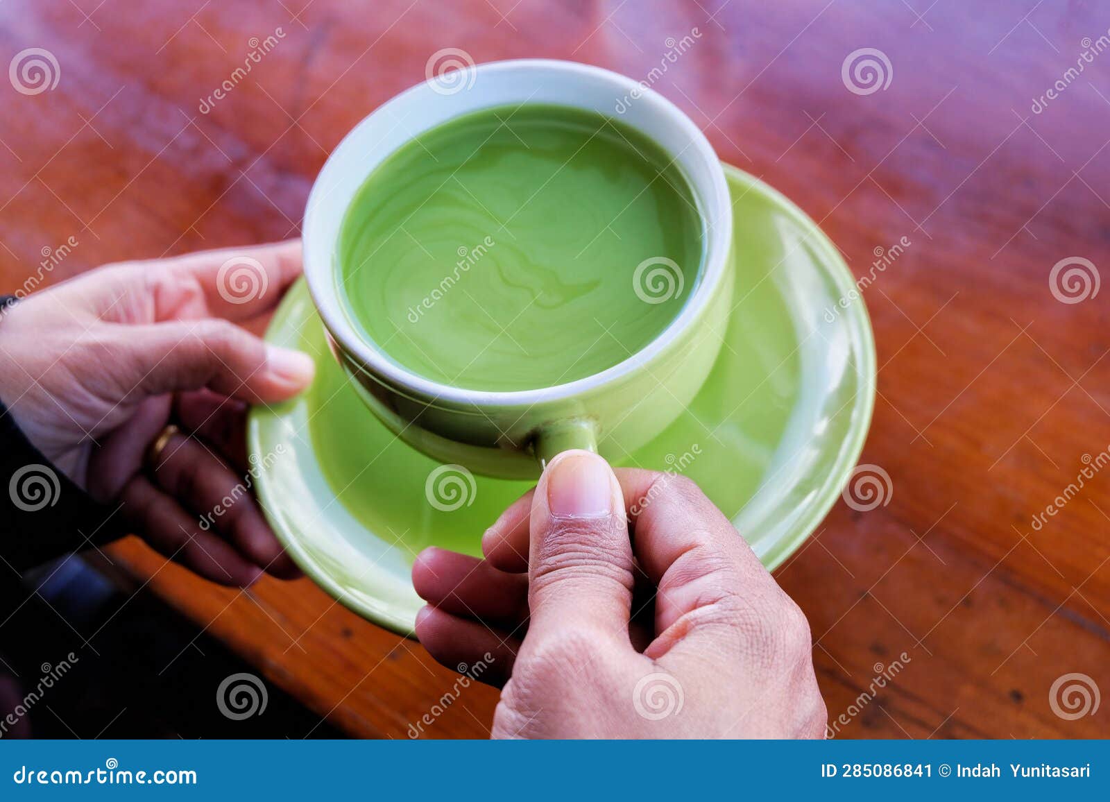 Cup of Hot Milk Green Tea in Hand Above the Table Stock Image - Image ...