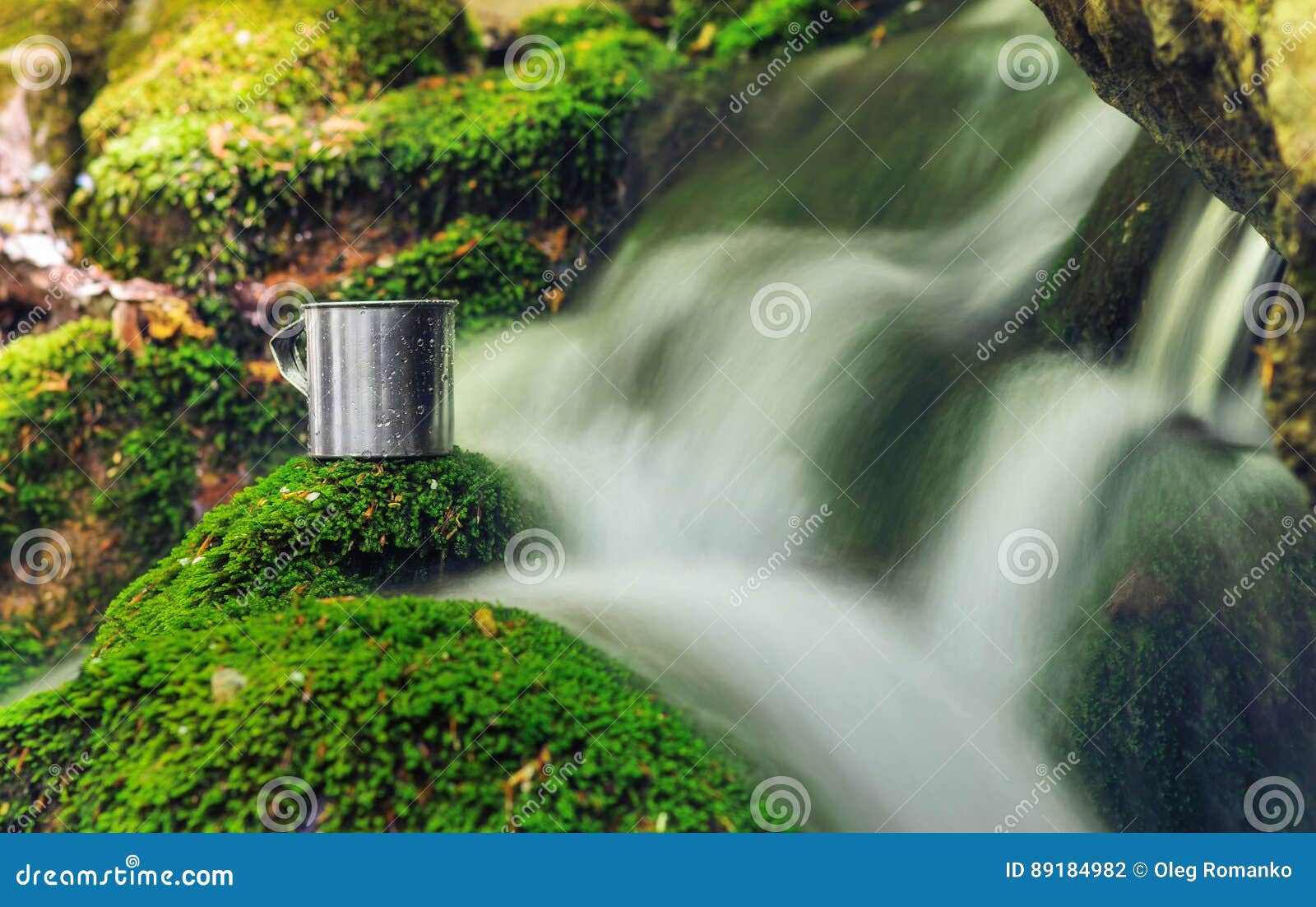 Cup of Pure Water with Drops on the Mountain River with Stones Stock ...