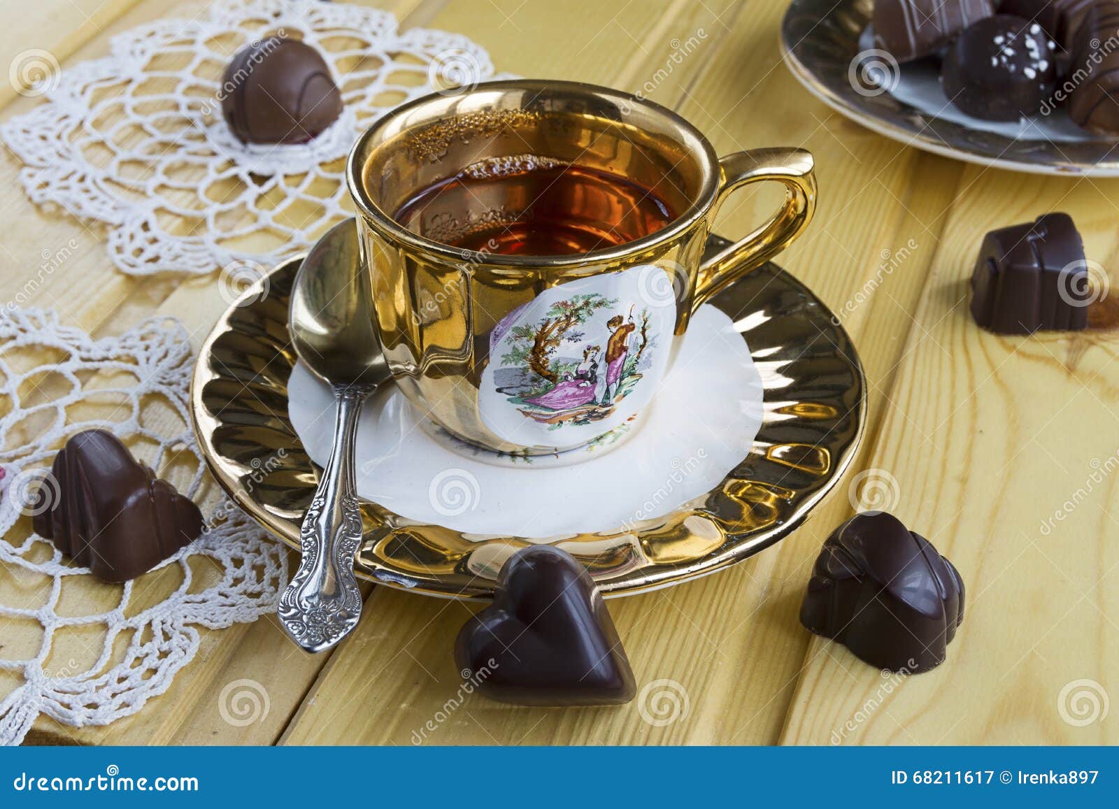 A Cup of Tea with Chocolate Candies on Wooden Table Stock Image - Image ...