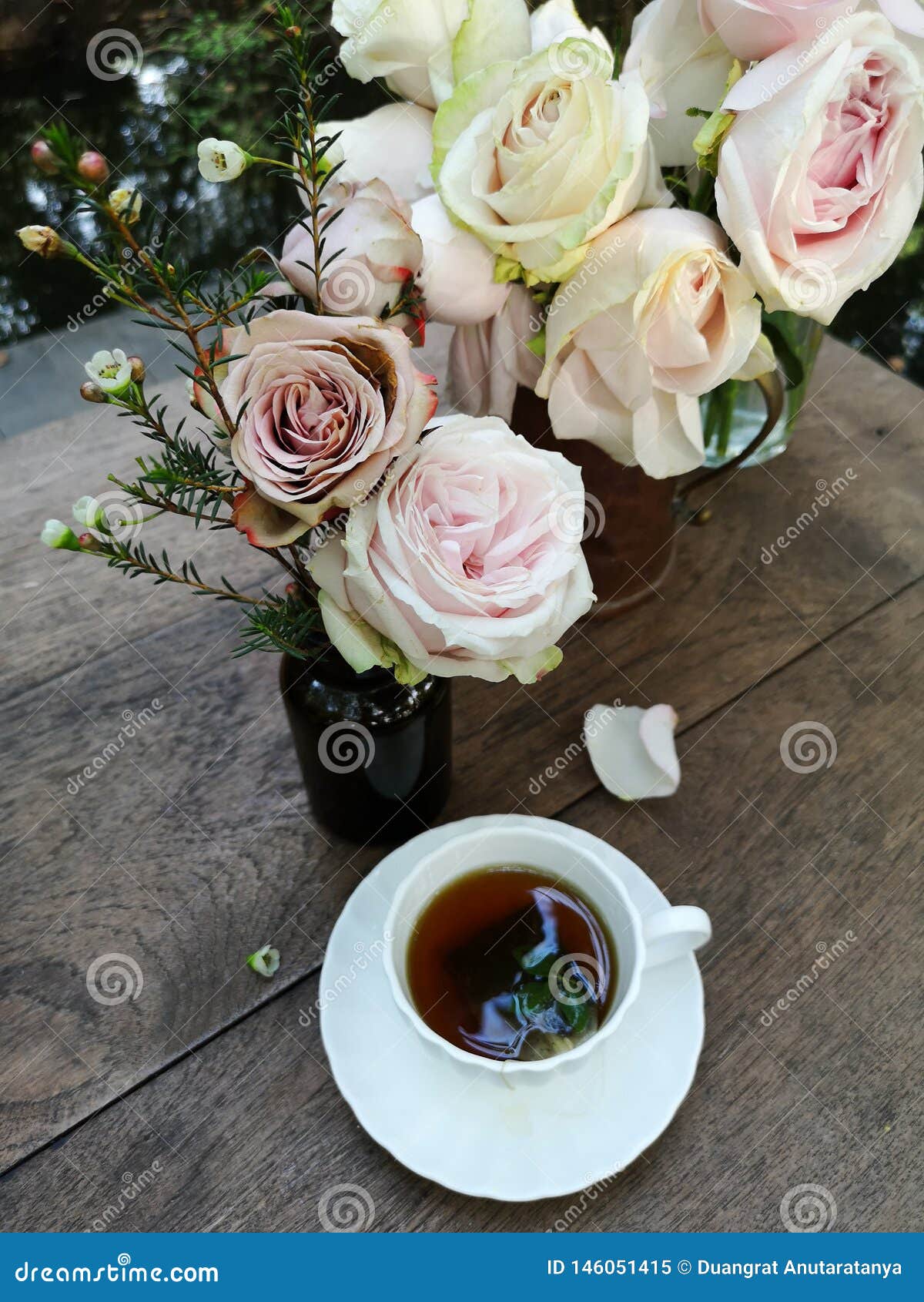 A Cup of Tea with Gorgeous Bouquet of Fresh Roses on the Table in the ...
