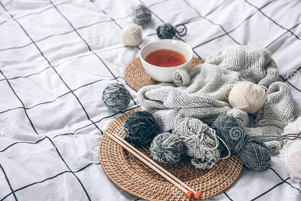A Cup of Tea, Knitting Threads and Knitted Elements in the Bed. Stock ...