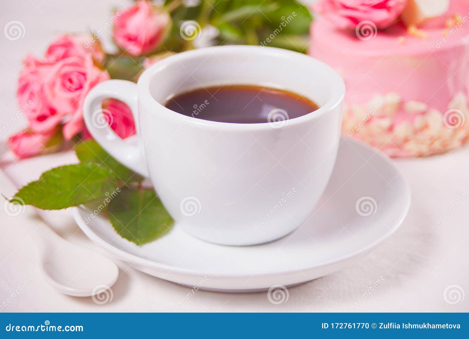 A Cup of Tea, Pink Roses and Small Cake on the White Table Stock Photo ...