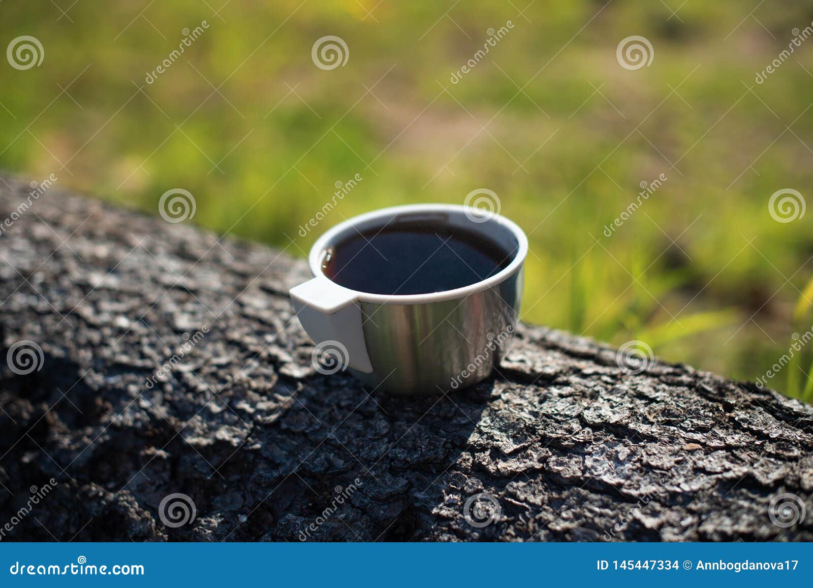 Cup of tea on a tree trunk stock photo. Image of organic - 145447334