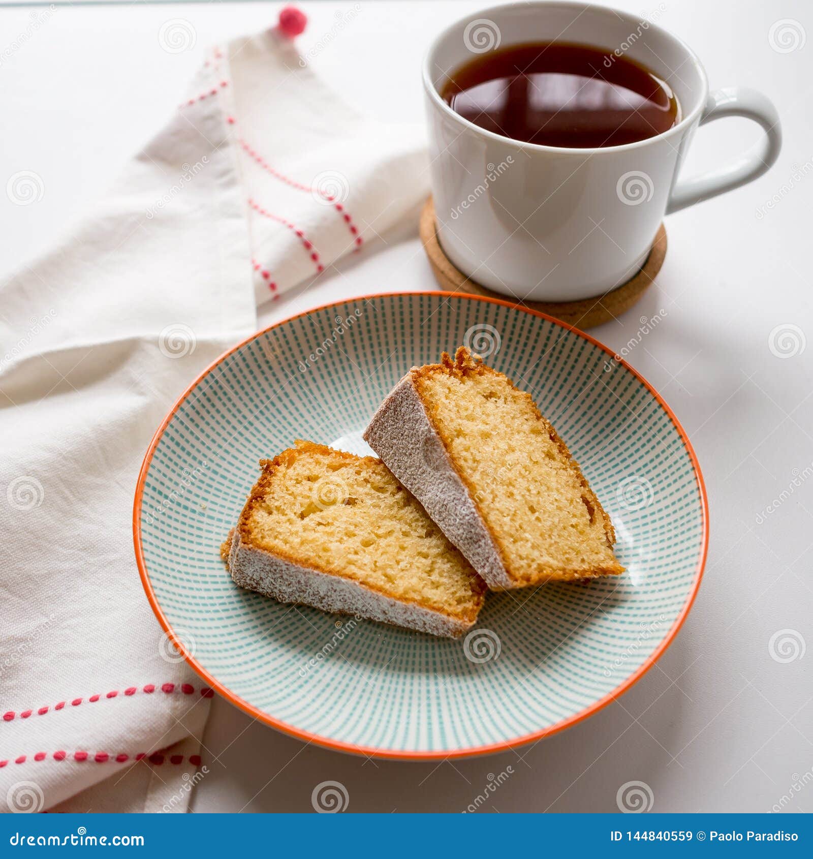 Cup of Tea and Two Slices of Sponge Cake in a Plate on a White Table ...