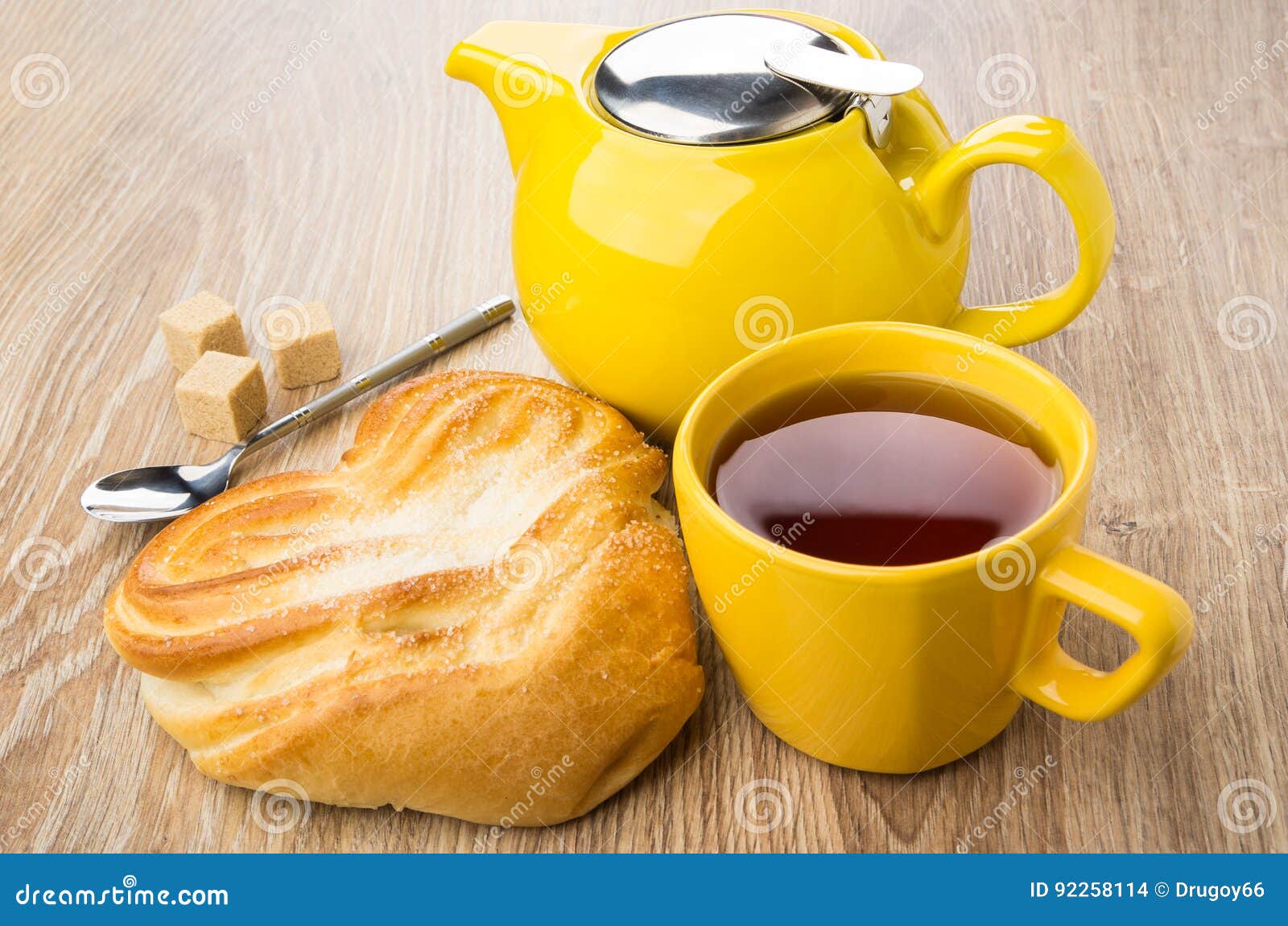 Cup of Tea, Yellow Teapot, Spoon and Bun with Sugar Stock Photo - Image ...