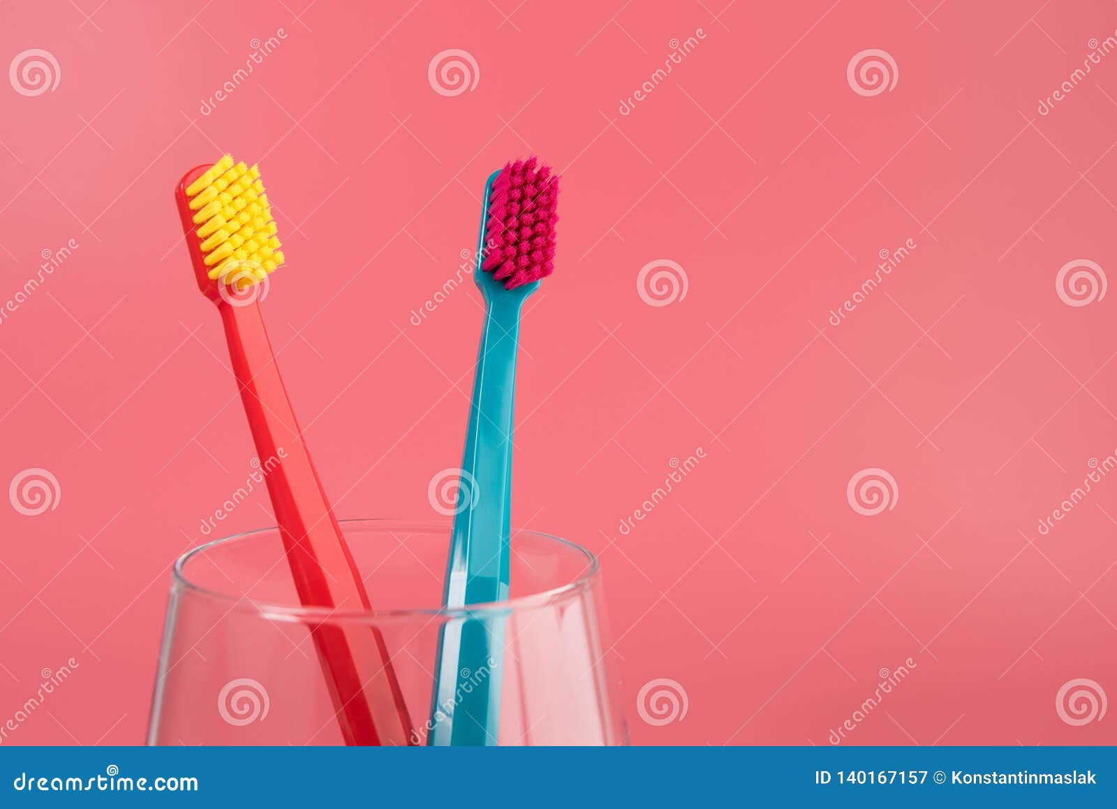 Cup with Toothbrushes on Table Against Color Background. Stock Image ...