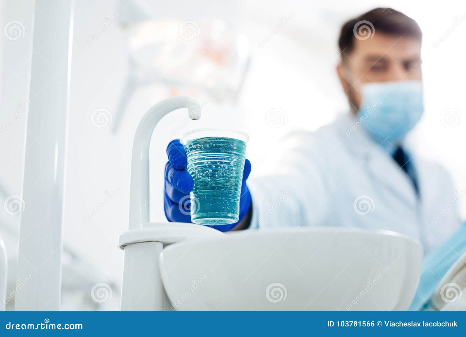 A Cup of Water in Hands of Skilled Dentist Stock Photo - Image of ...