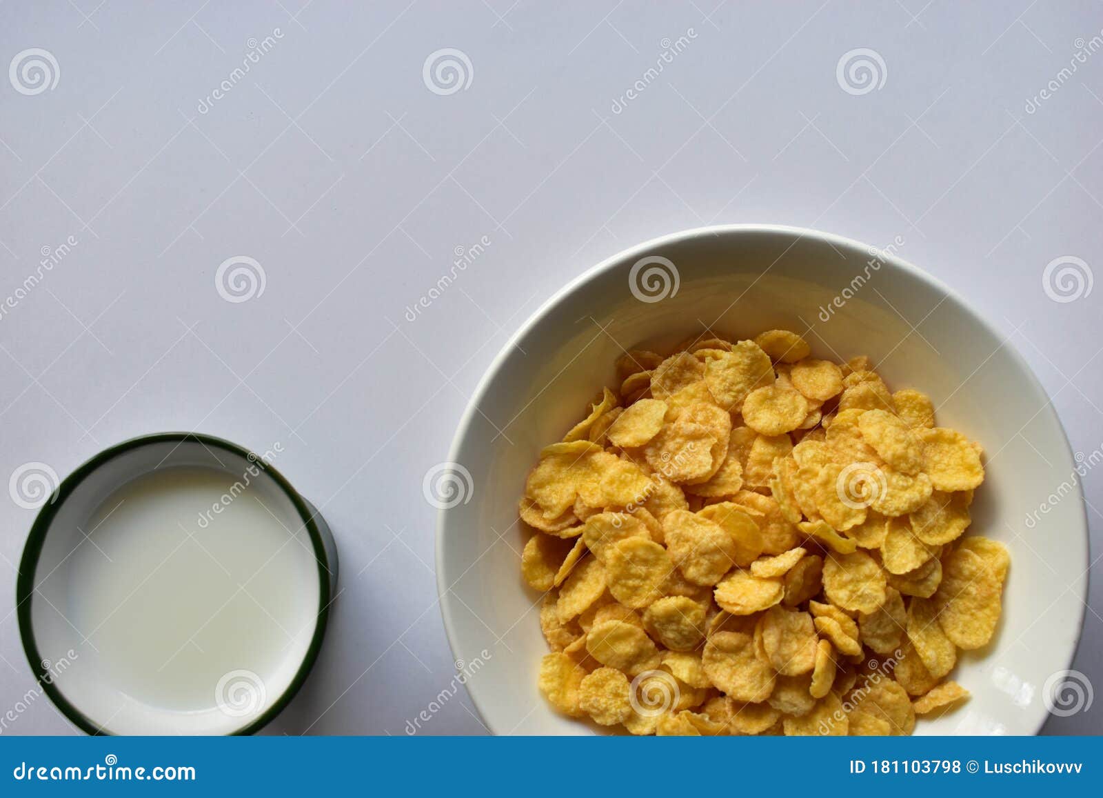A Cup of Yellow Cornflakes in Milk on a White Background Stock Photo ...