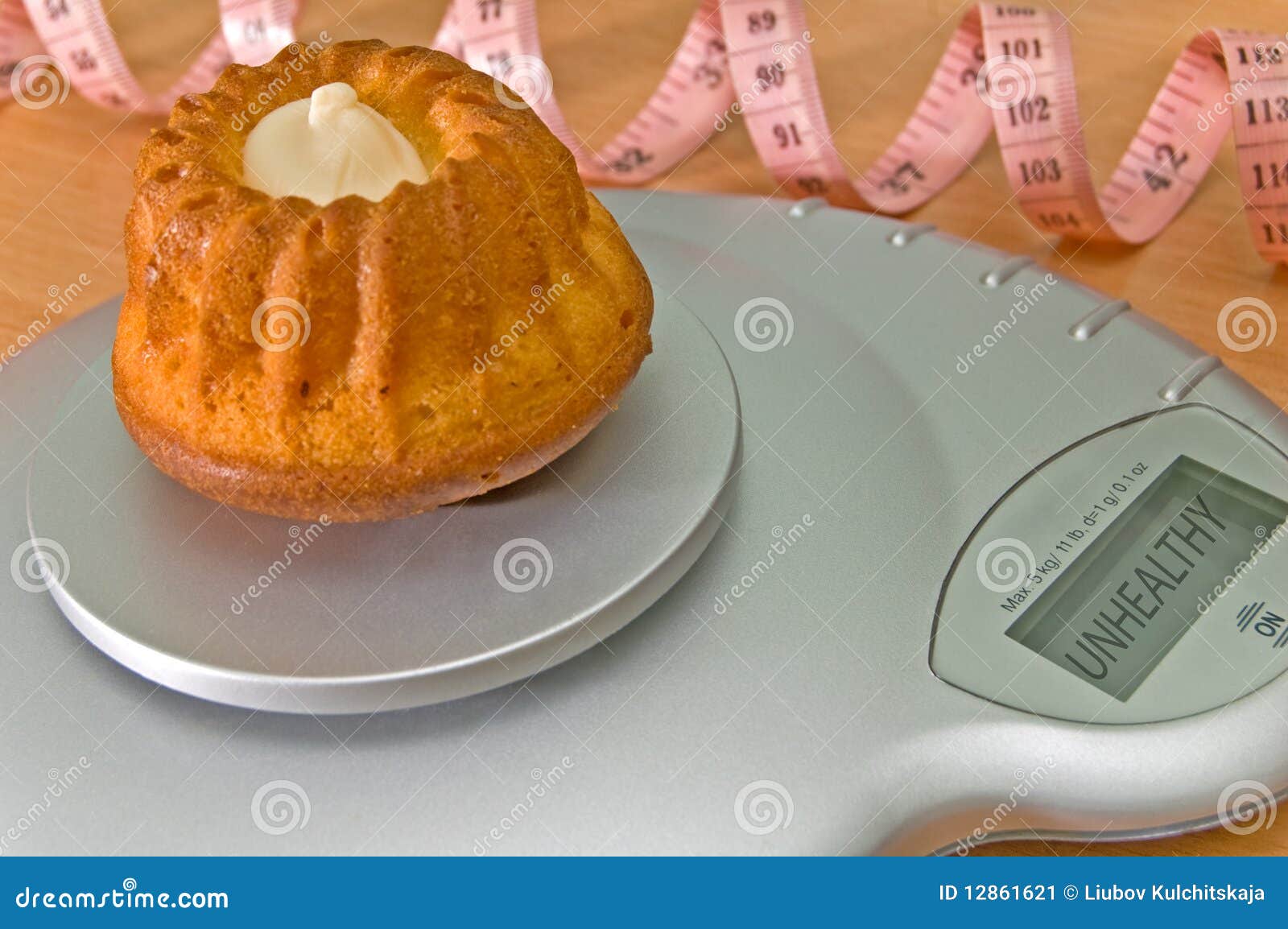 A Cupcake On The Scales Stock Photo | CartoonDealer.com #90124104