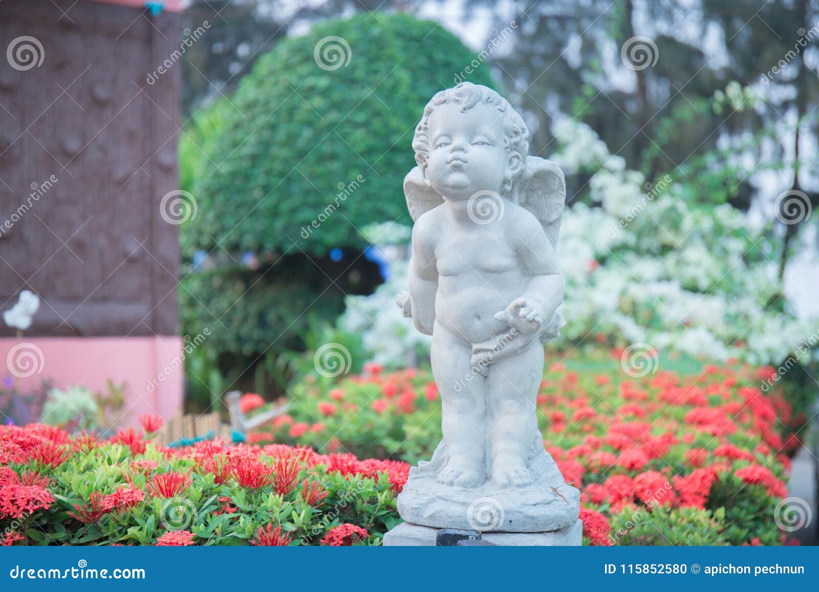 Cupid Stone Statue in the Flower Garden. Stock Photo - Image of green ...