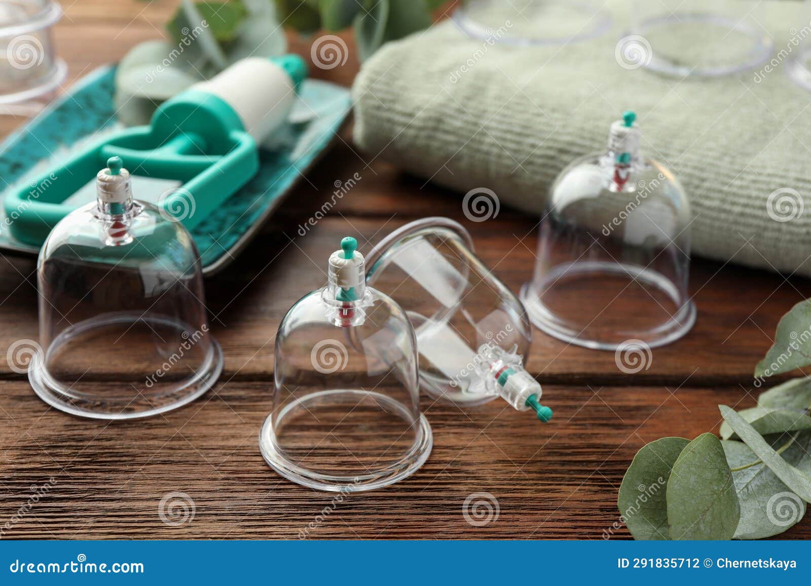 Cupping Therapy. Plastic Cups and Eucalyptus Leaves on Wooden Table ...