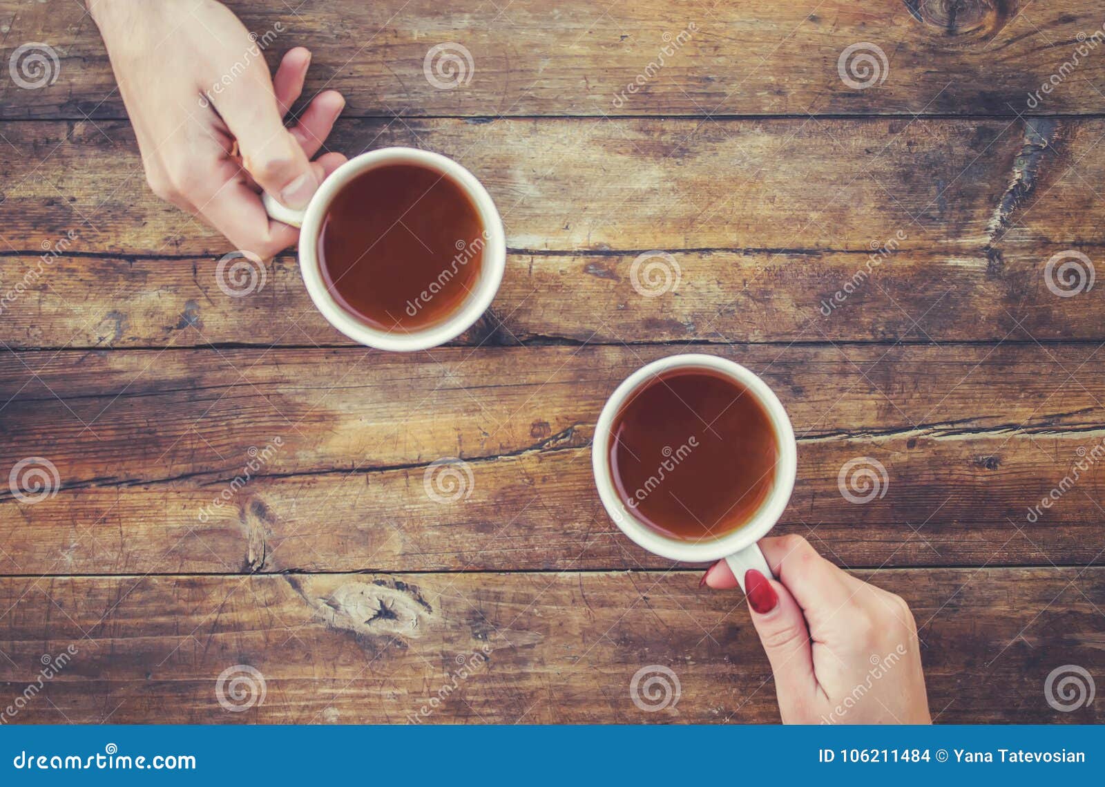 Cups of tea in the hands stock photo. Image of banner - 106211484