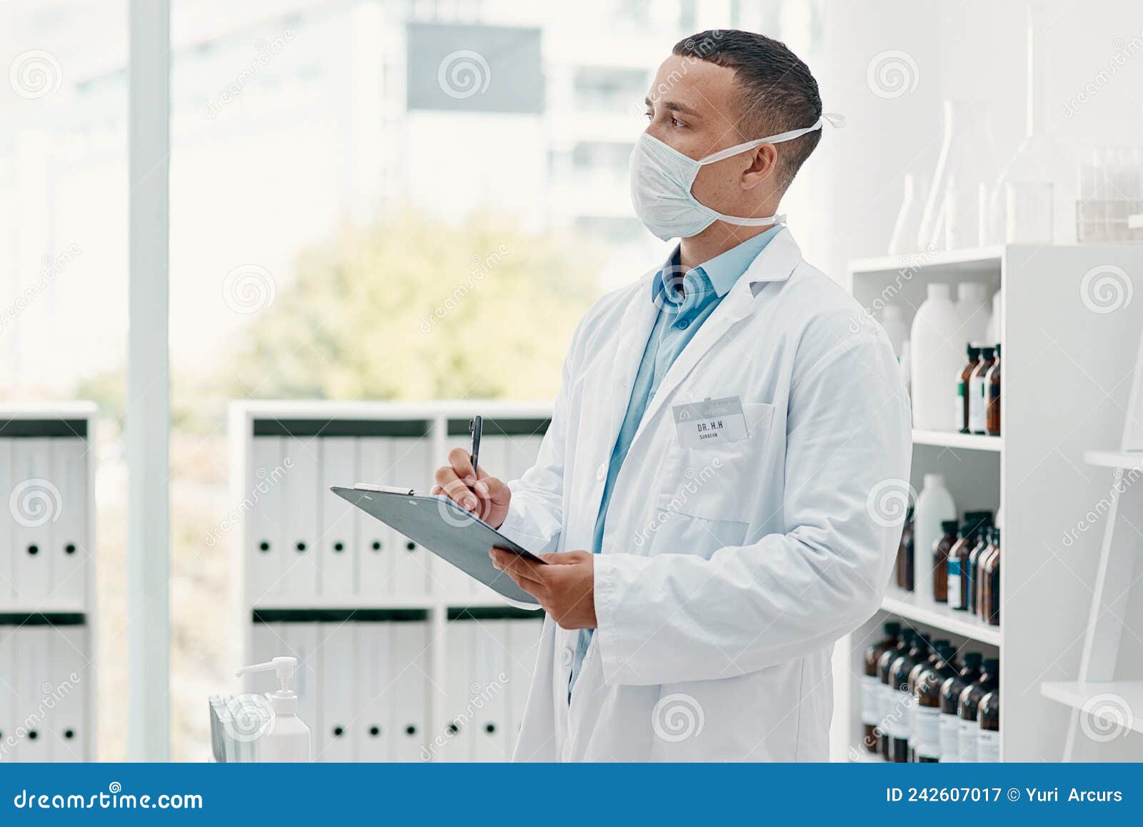 The Cure for Fear is Knowledge. Shot of a Young Scientist Writing Notes ...
