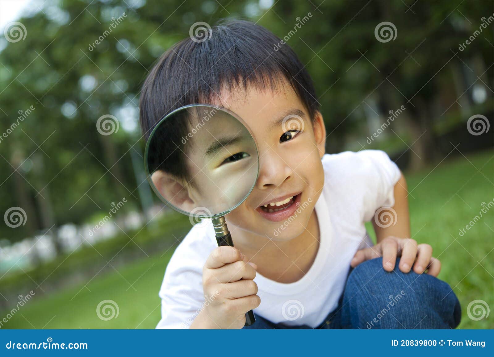 Curious boy with magnifier stock photo. Image of nature - 20839800