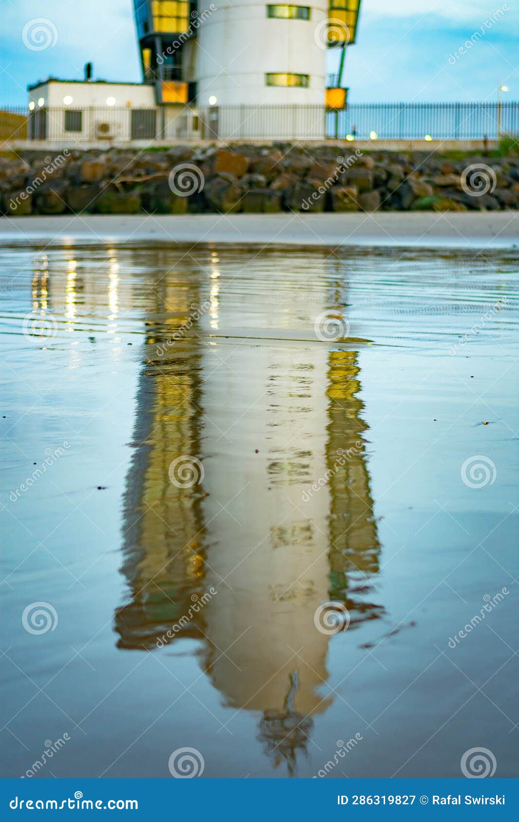 Curious Building at the Beach Reflected on the Wet Sand. Stock Image ...