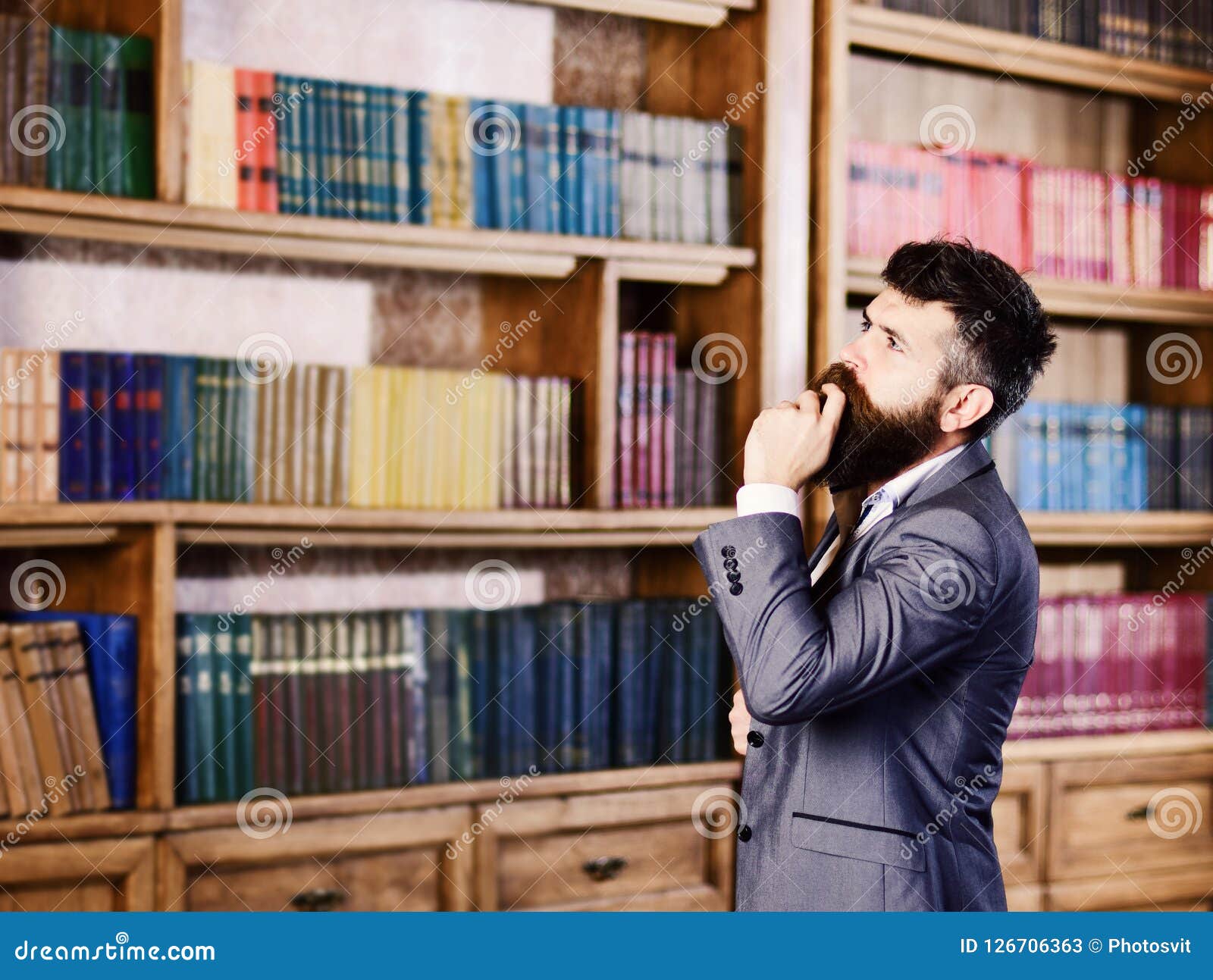 Curious Man Choosing Book in His Library at Home Stock Image - Image of ...