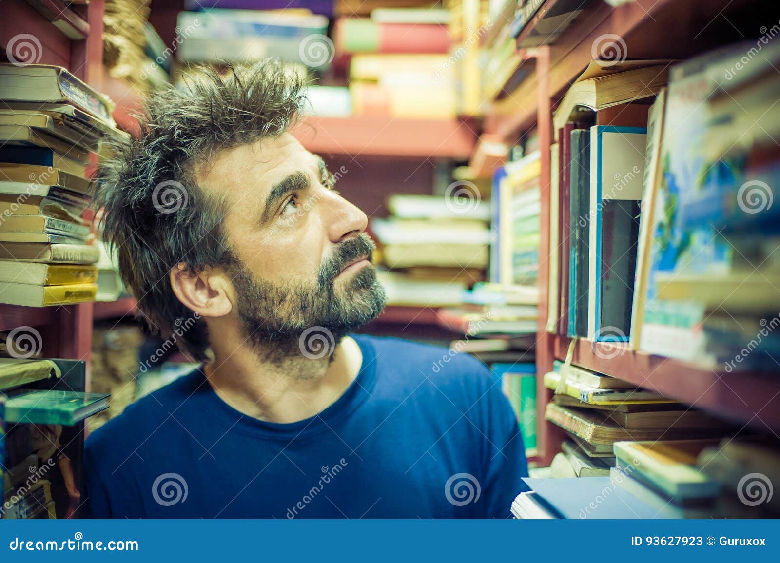 Curious Man Choosing Book between the Shelves in the Library Stock ...