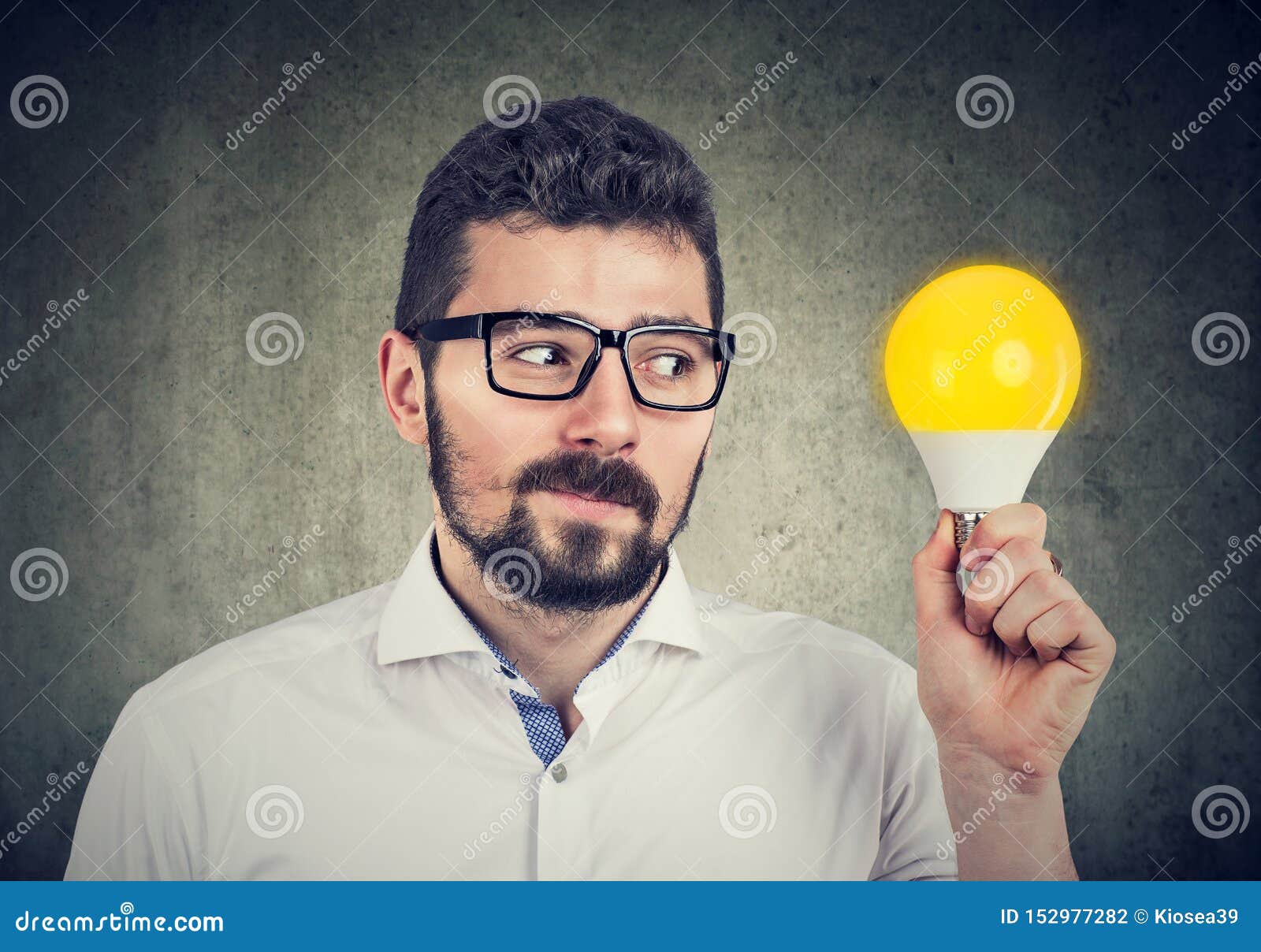 Curious Man Holding Looking at Bright Light Bulb Stock Photo - Image of ...