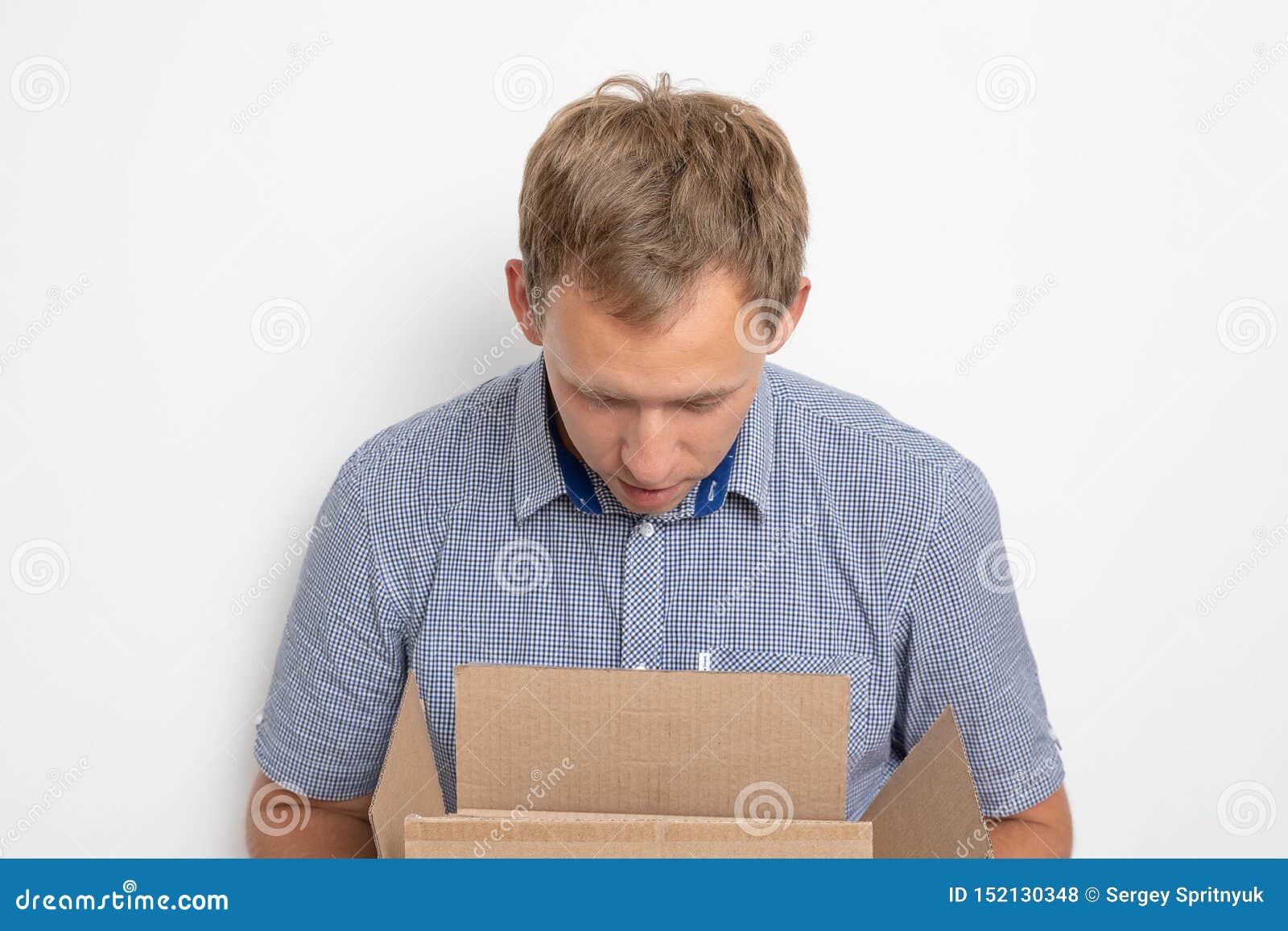 Curious Man Looking Inside a Cardboard Box he Holds in His Hands on a ...