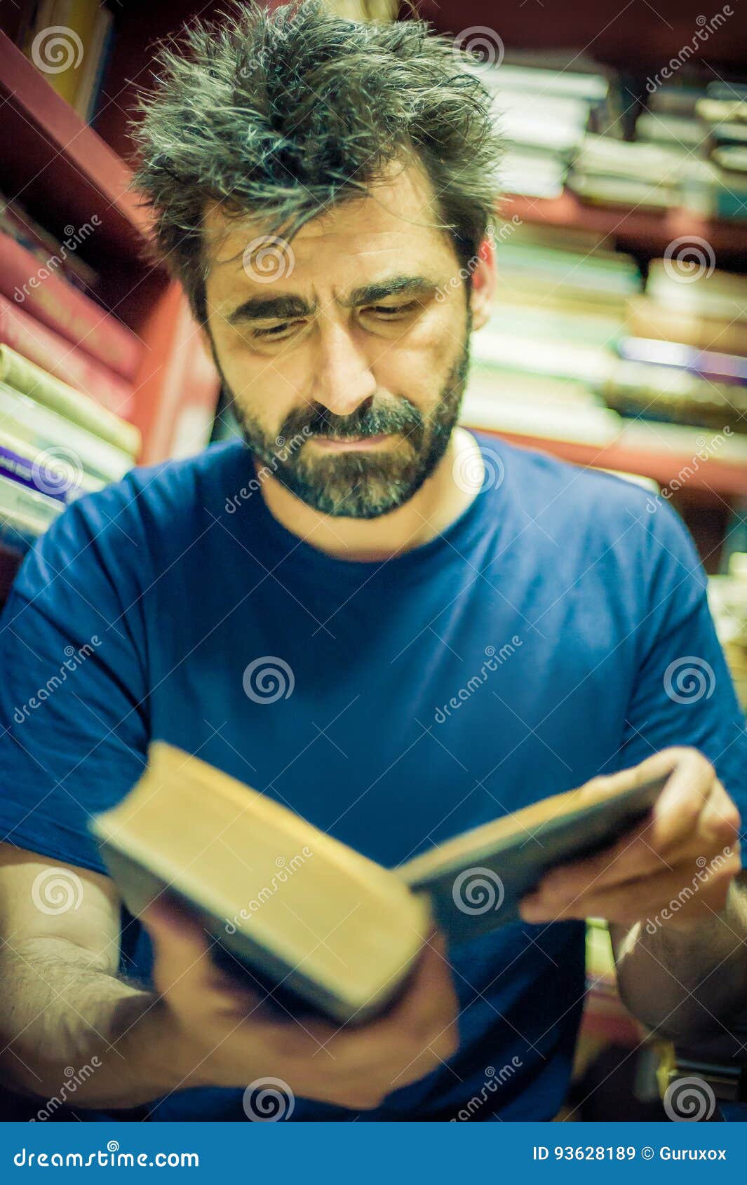 Curious Man Reading Book between the Shelves in the Library Stock Image ...