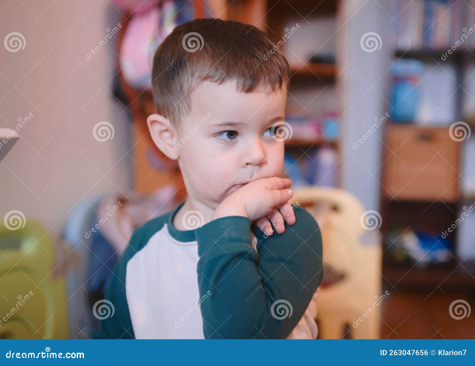 Curious Young Boy Watching Intently while Bending His Wrist Stock Photo ...