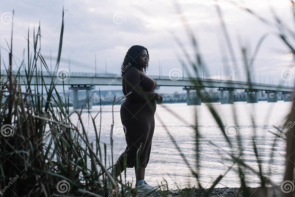 Curly Black Haired Smiling Plump African American Dark Skin Woman