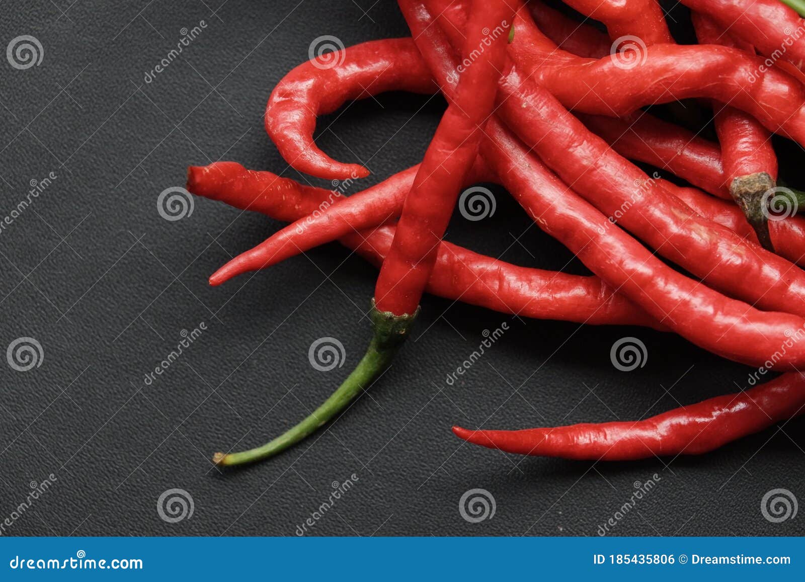 Curly Chili Pepper on Black Isolated Background Stock Photo - Image of ...