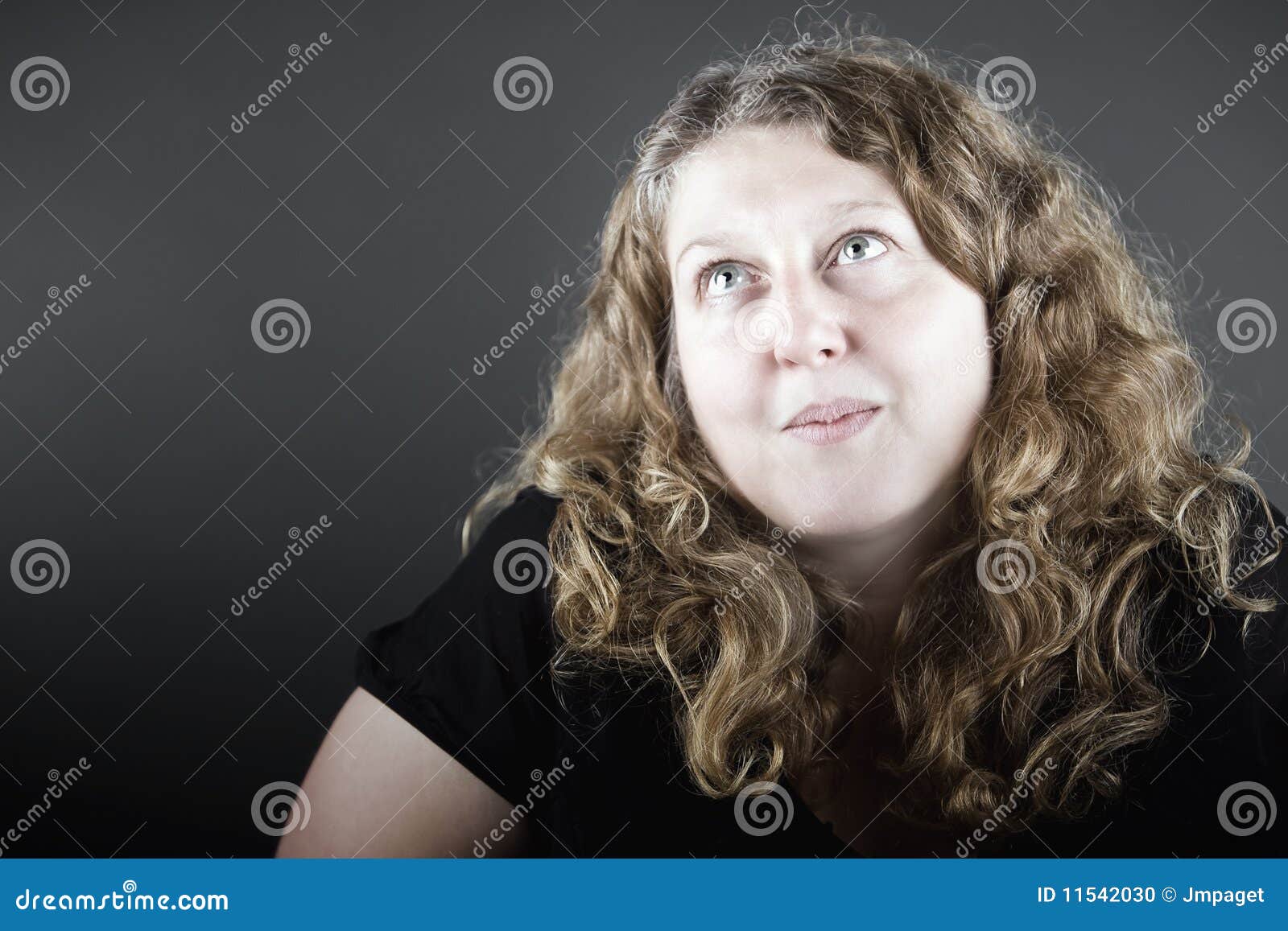 Curly Haired Lady Looking Up Off Camera Stock Photo - Image of people ...