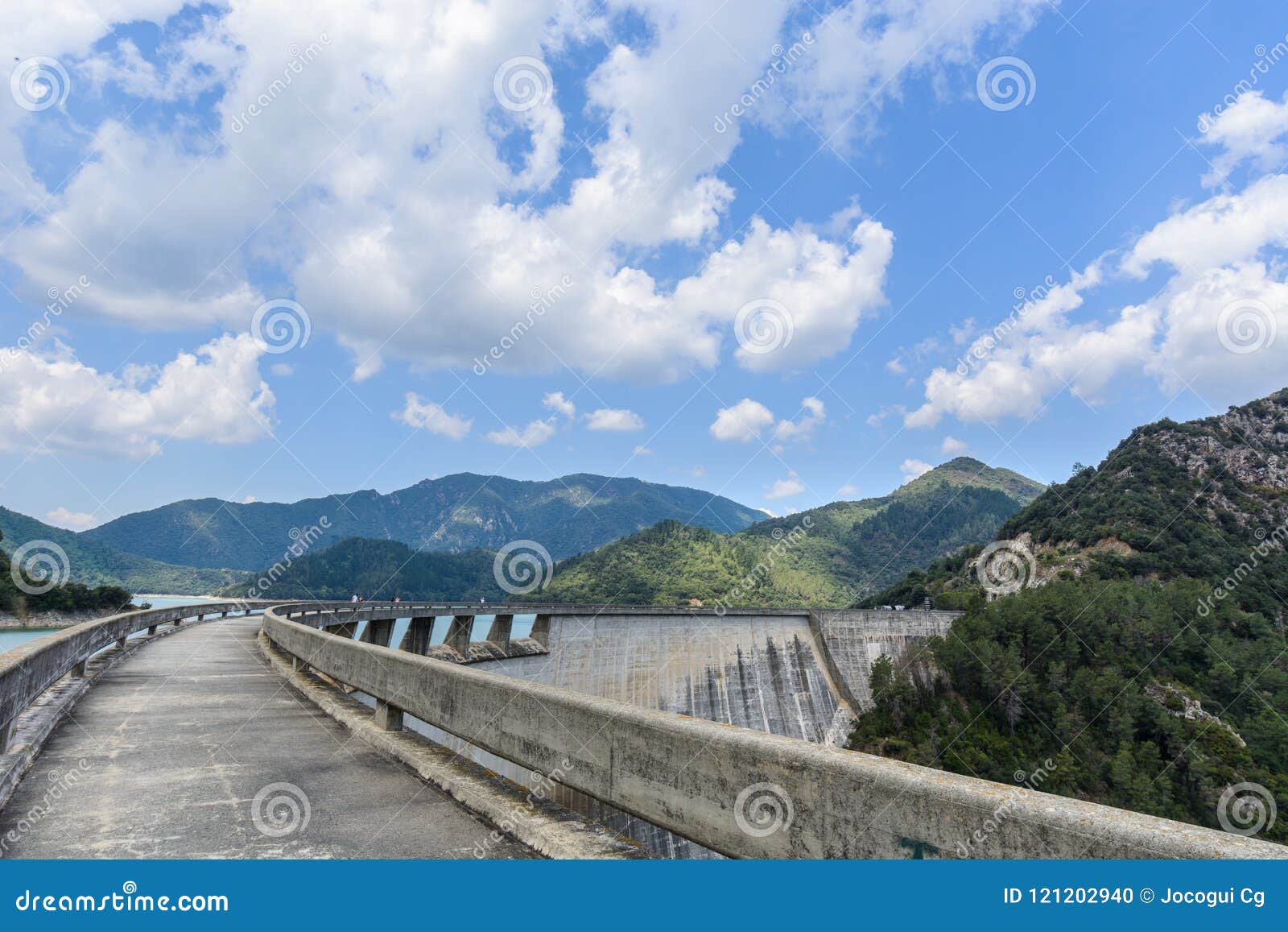Curved Dam Path & Mountains Under Clouds Stock Photo - Image of ...