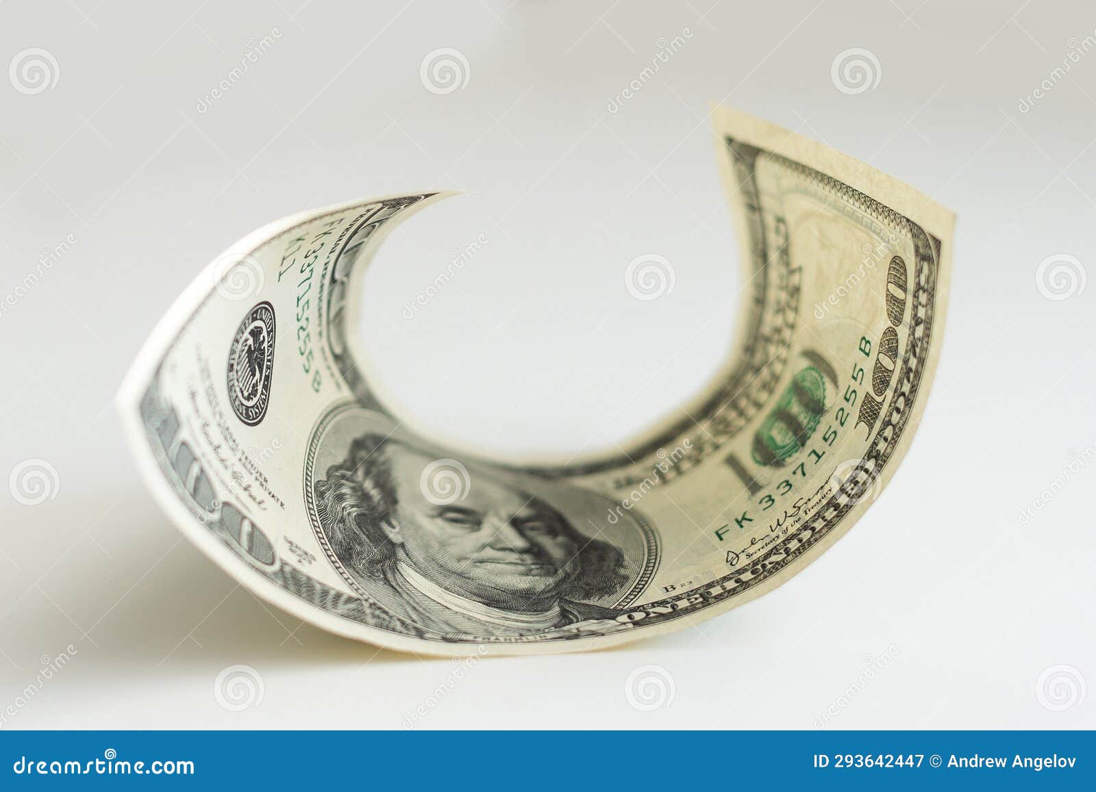 Curved Hundred-dollar Bill Close Up on a Light Plane. Stock Image ...