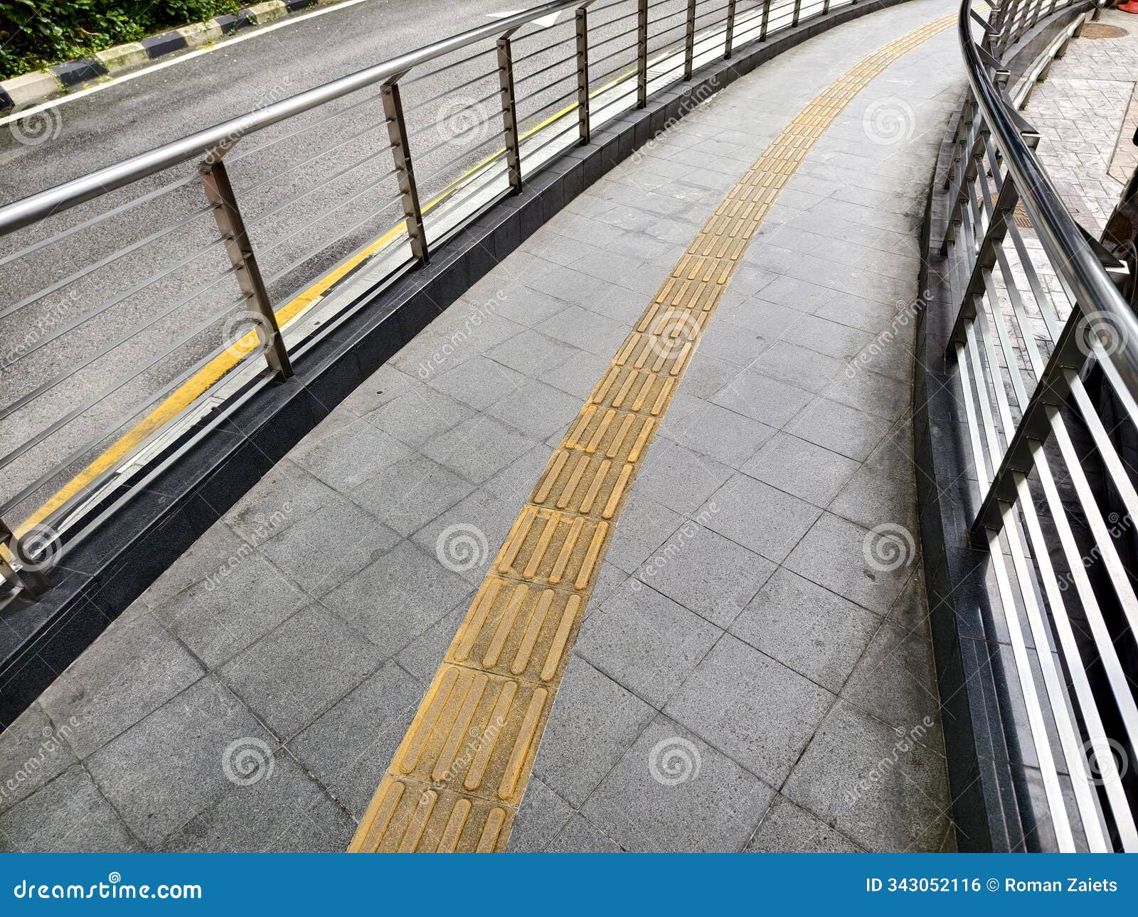 Curved Path with Guardrail and Yellow Line for Blind People Along the ...