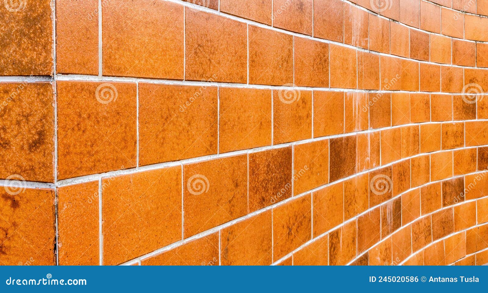 The Curved Wall of the Building in the City is Covered with Red Tiles ...