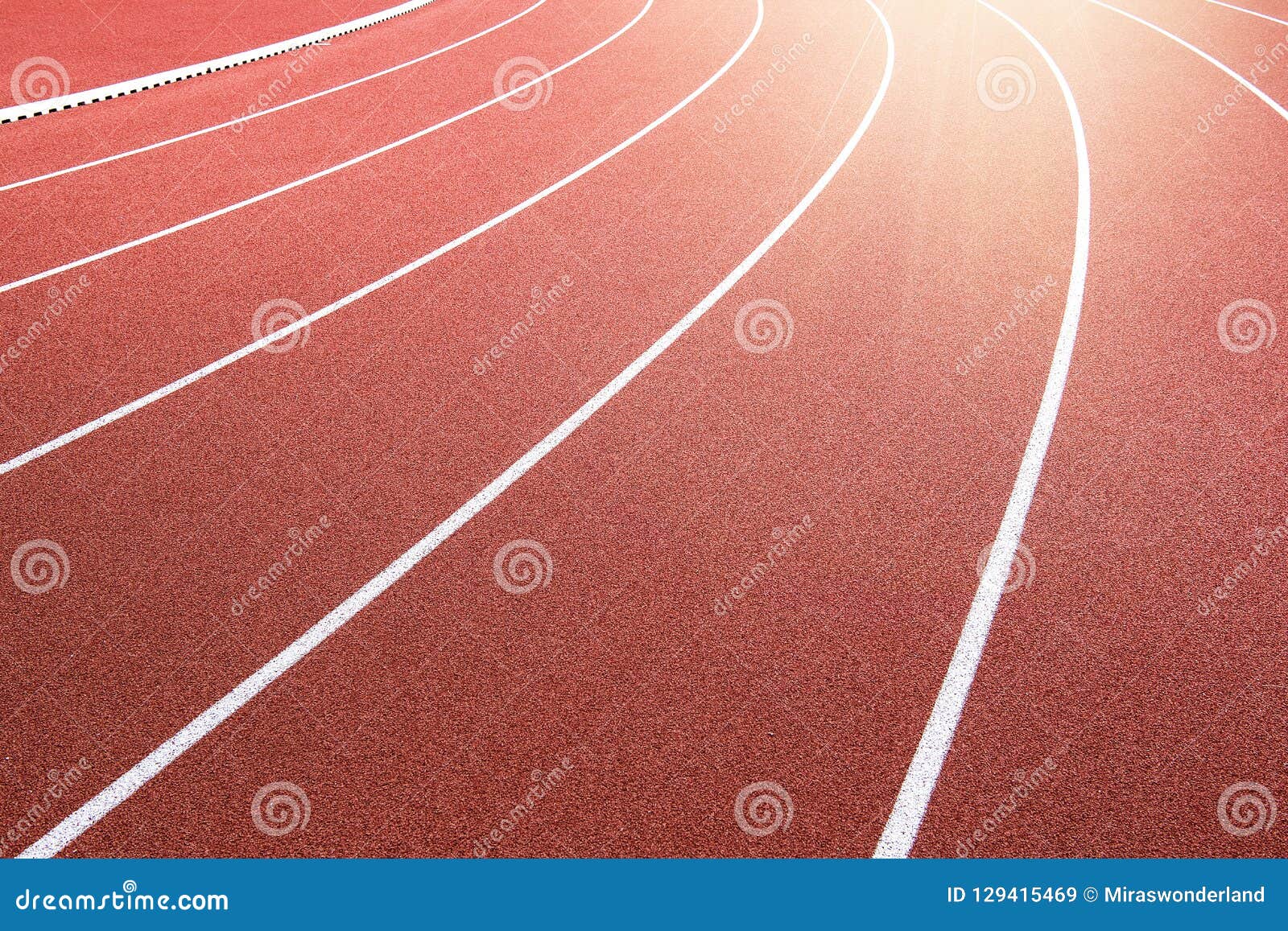 Curved White Lines on a Red Running Track with Sunlight at the a Stock ...