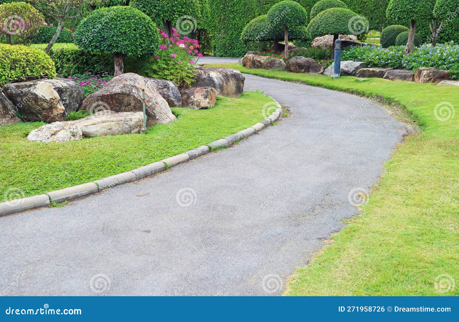 Curvy Pathway in the Garden with Round Shaped Trees Stock Photo - Image ...