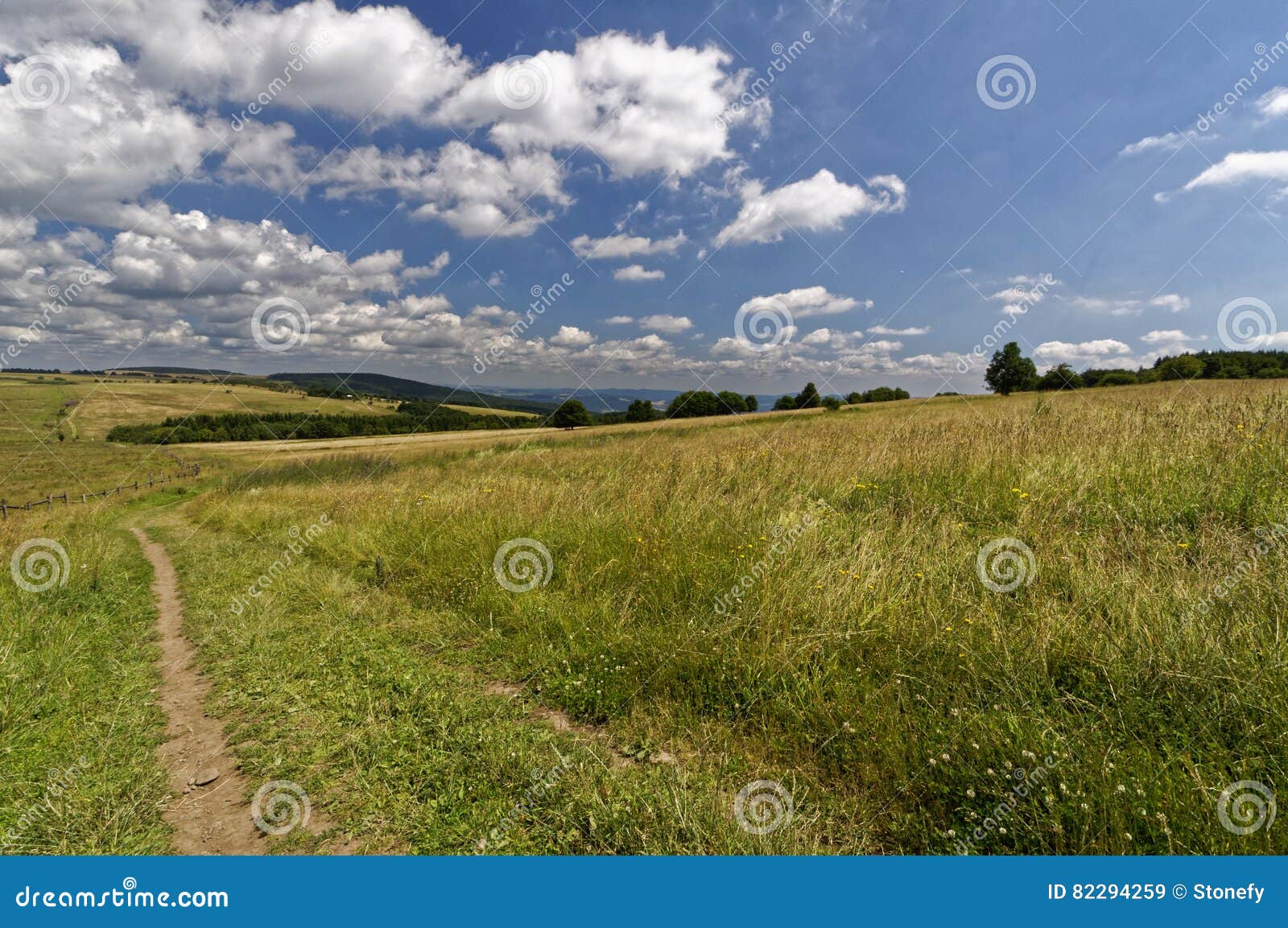 A Curvy and Sloping Green Grassland Stock Image - Image of hill ...