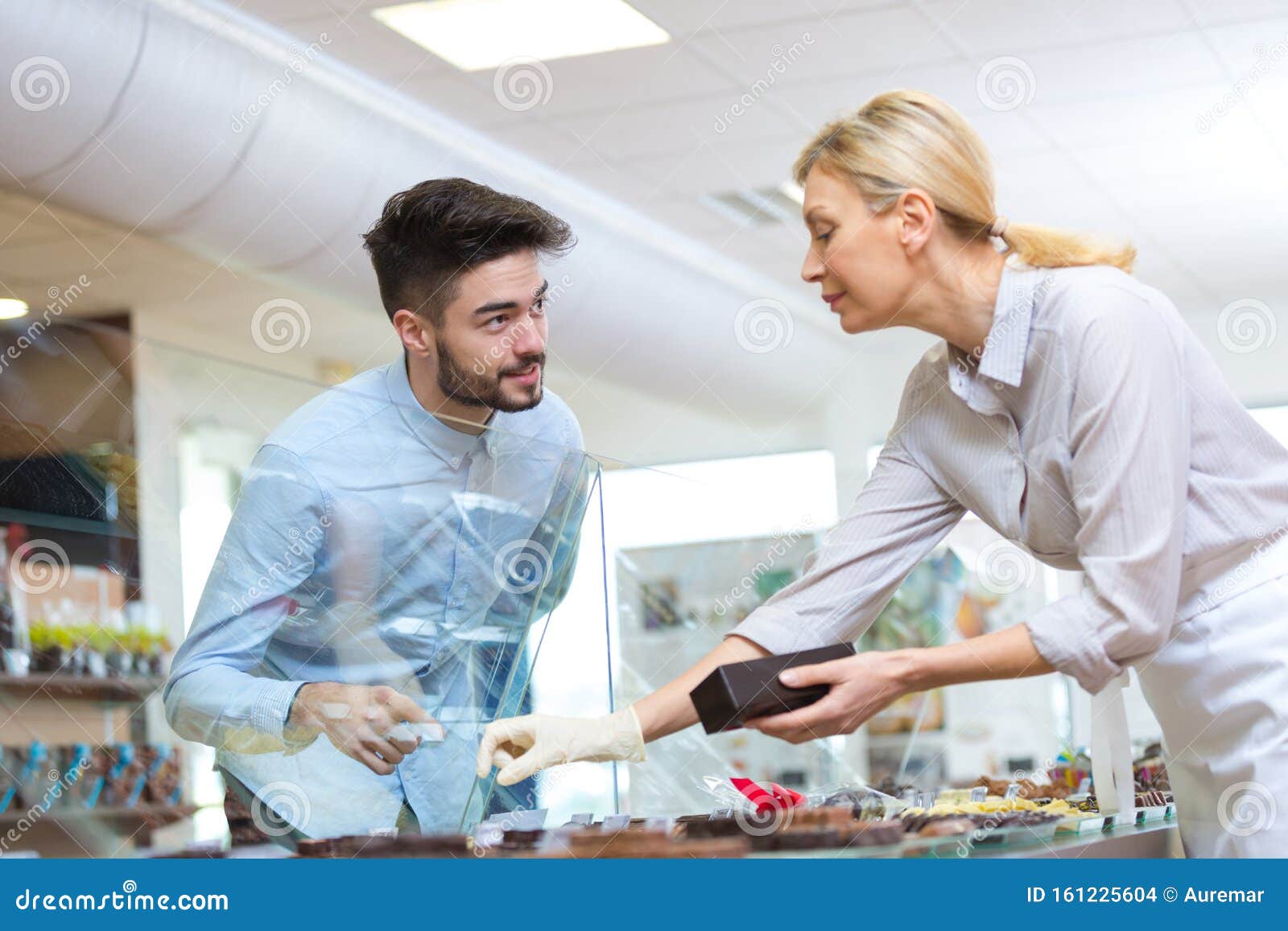 Customer Choosing Chocolates from Counter Stock Photo - Image of ...