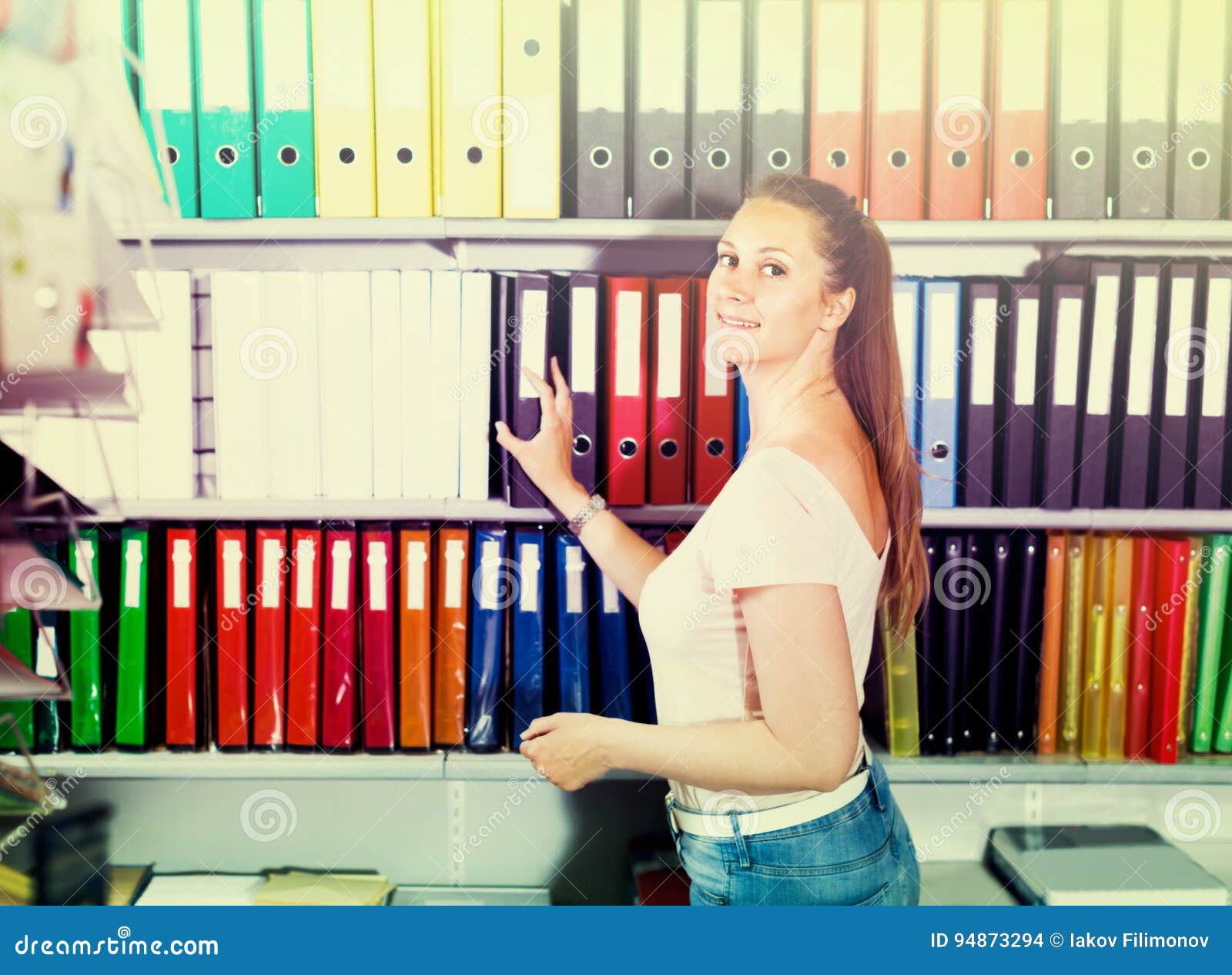 Customer is Choosing Folders on the Shelves Stock Photo - Image of ...