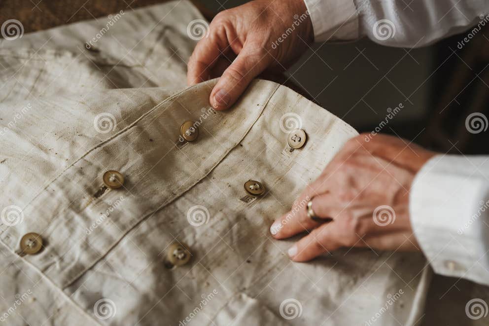 Customer Examining the Texture of a Linen Vest with Buttons Stock ...