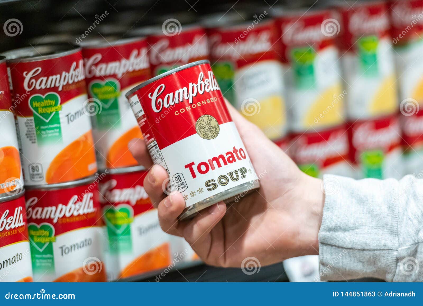 Customer Hand Holding A Tin Can Of Campbell’s Tomato Soup Editorial