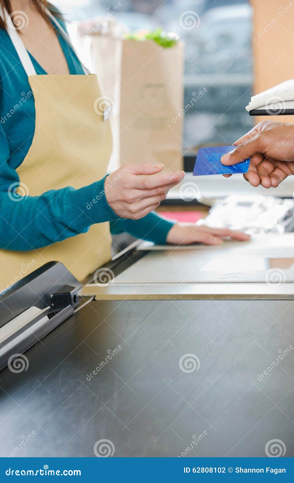 Customer Handing a Sales Assistant a Credit Card Stock Photo - Image of ...