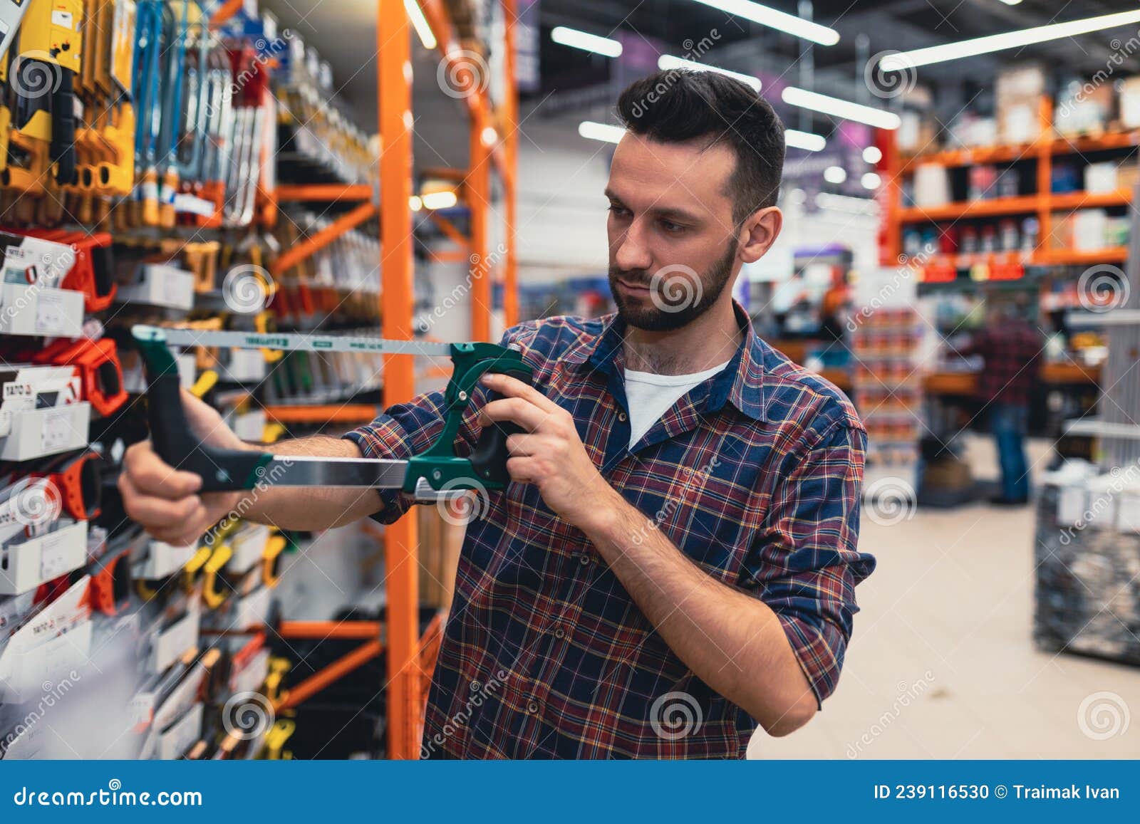 A Customer in a Hardware Store Chooses a Hacksaw for Metal Stock Photo ...