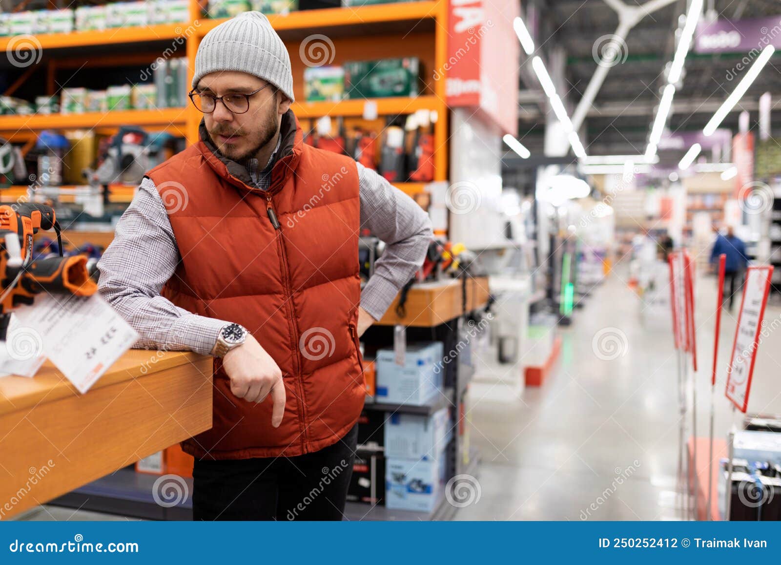 A Customer in a Hardware Store Inspects a Counter with Goods Stock ...